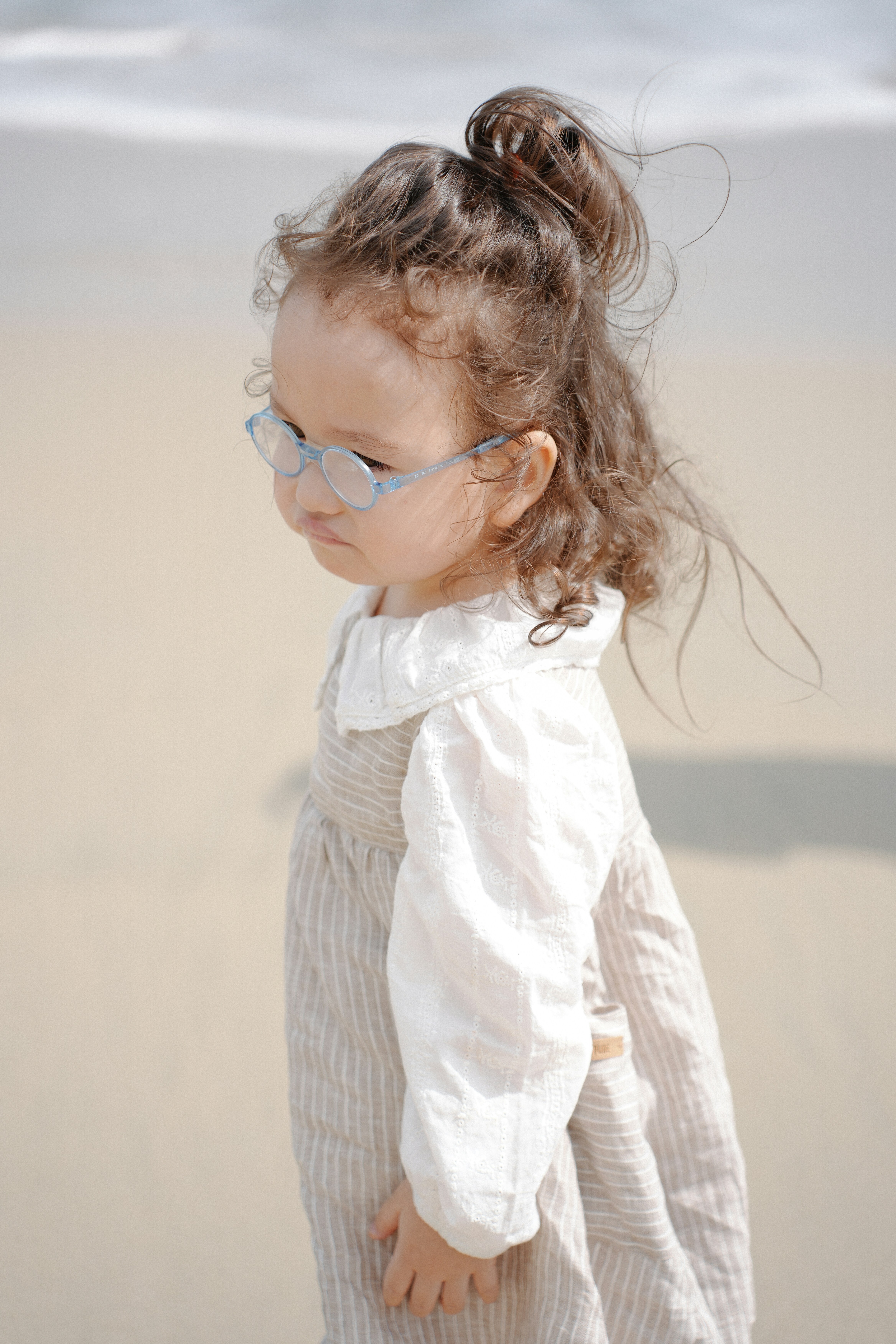 Girl in Glasses on a Sunlit Beach