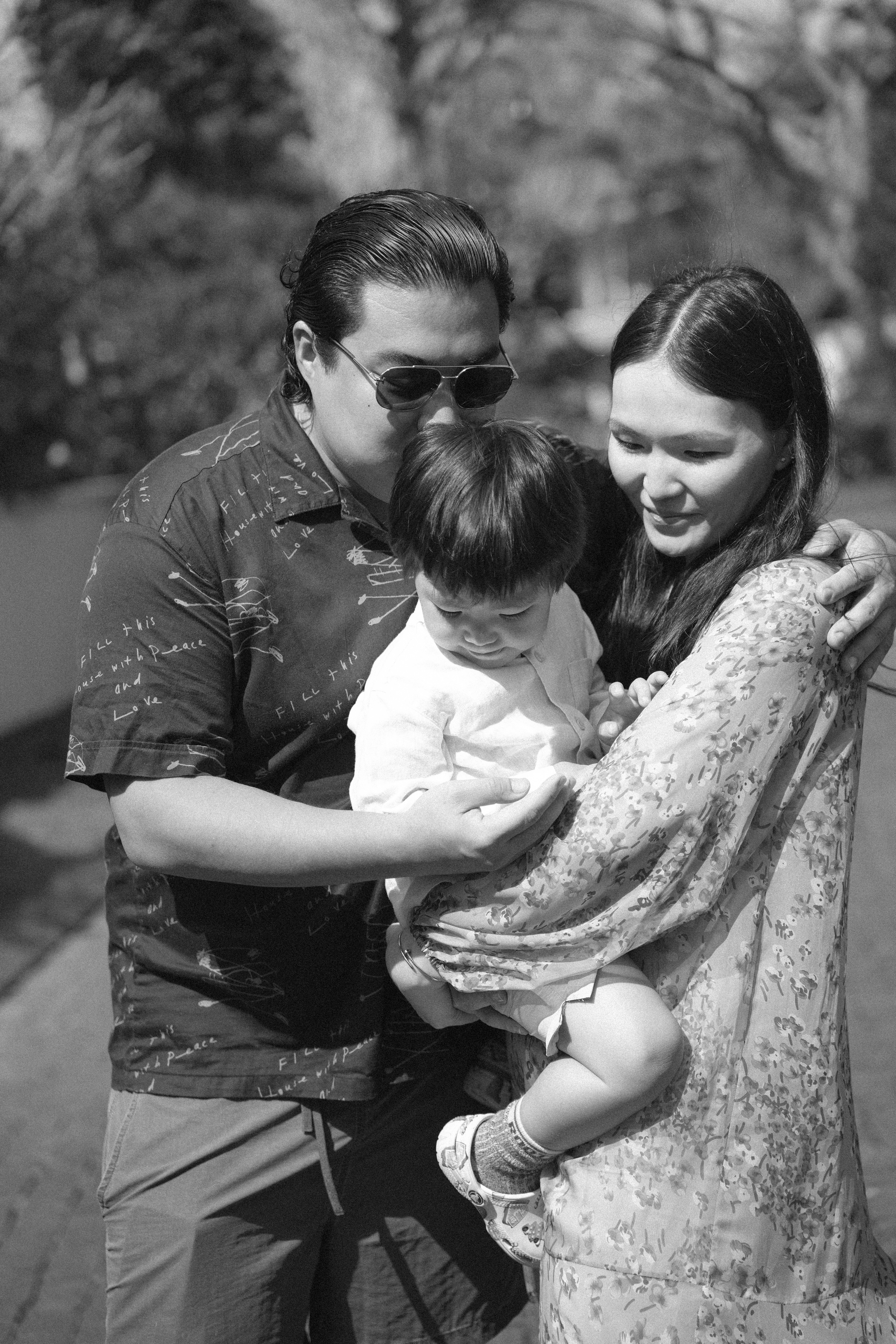 Parents holding their young child outdoors