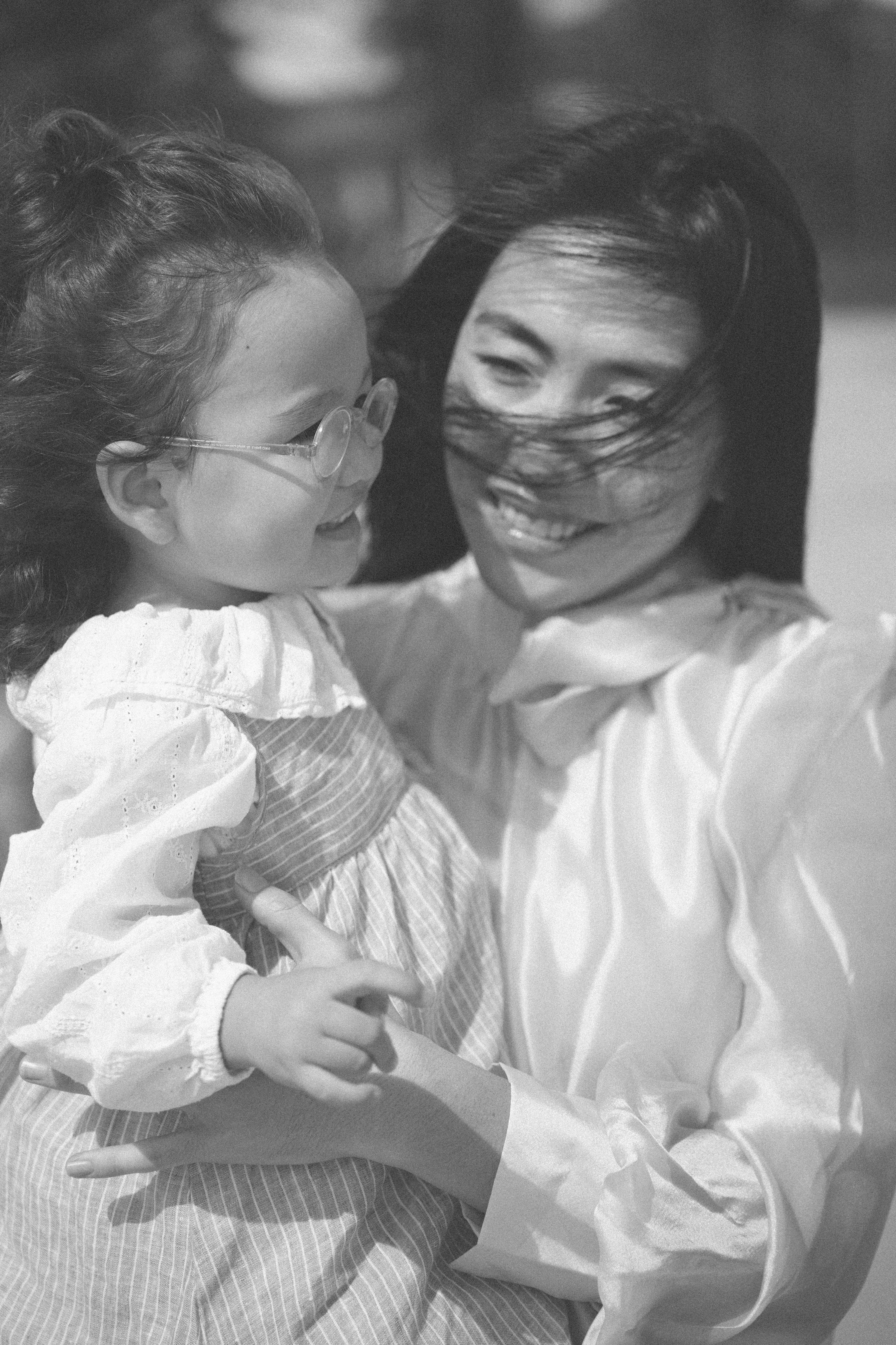 Mother and child smiling together outdoors