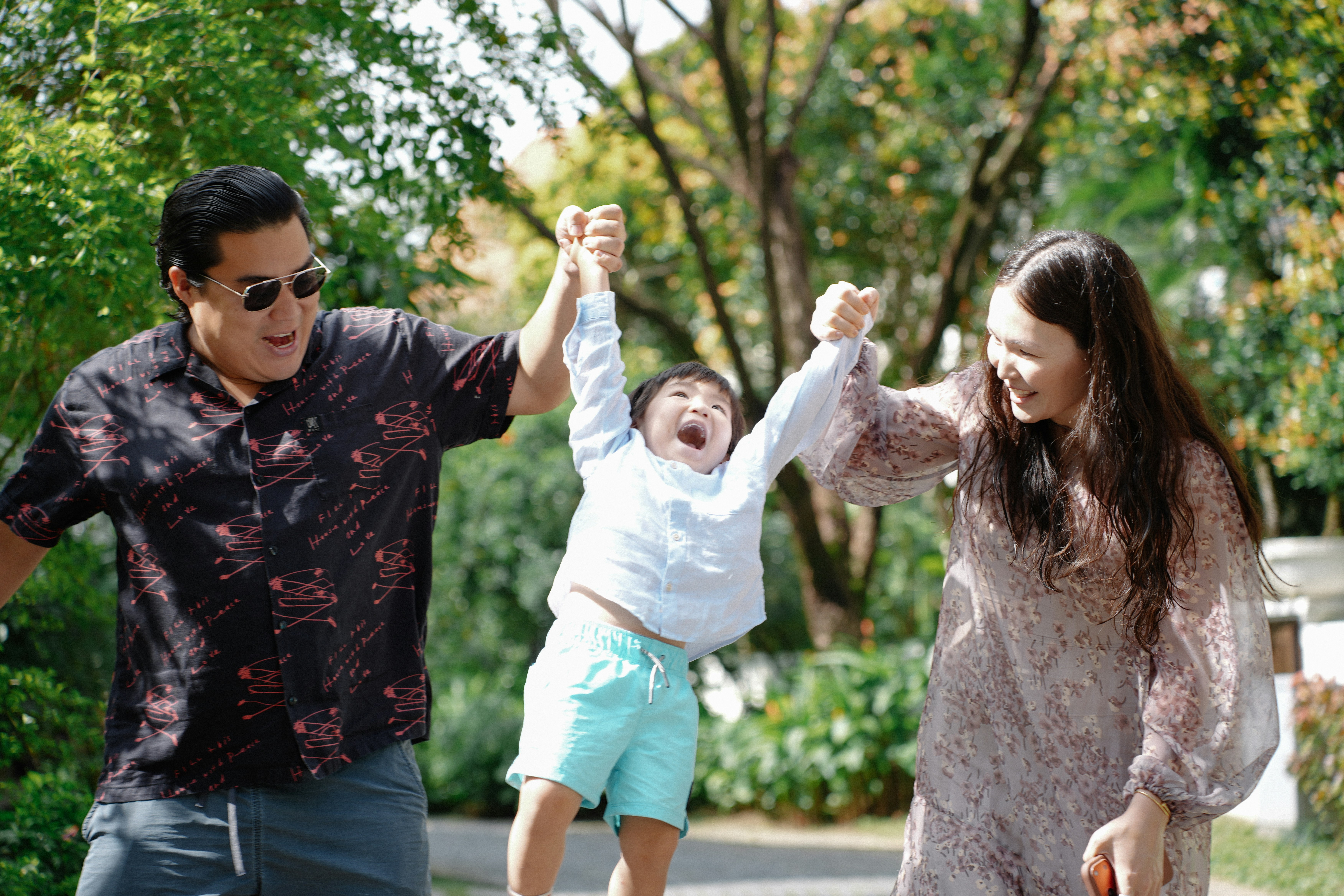 Joyful jump: a family moment in dappled park light