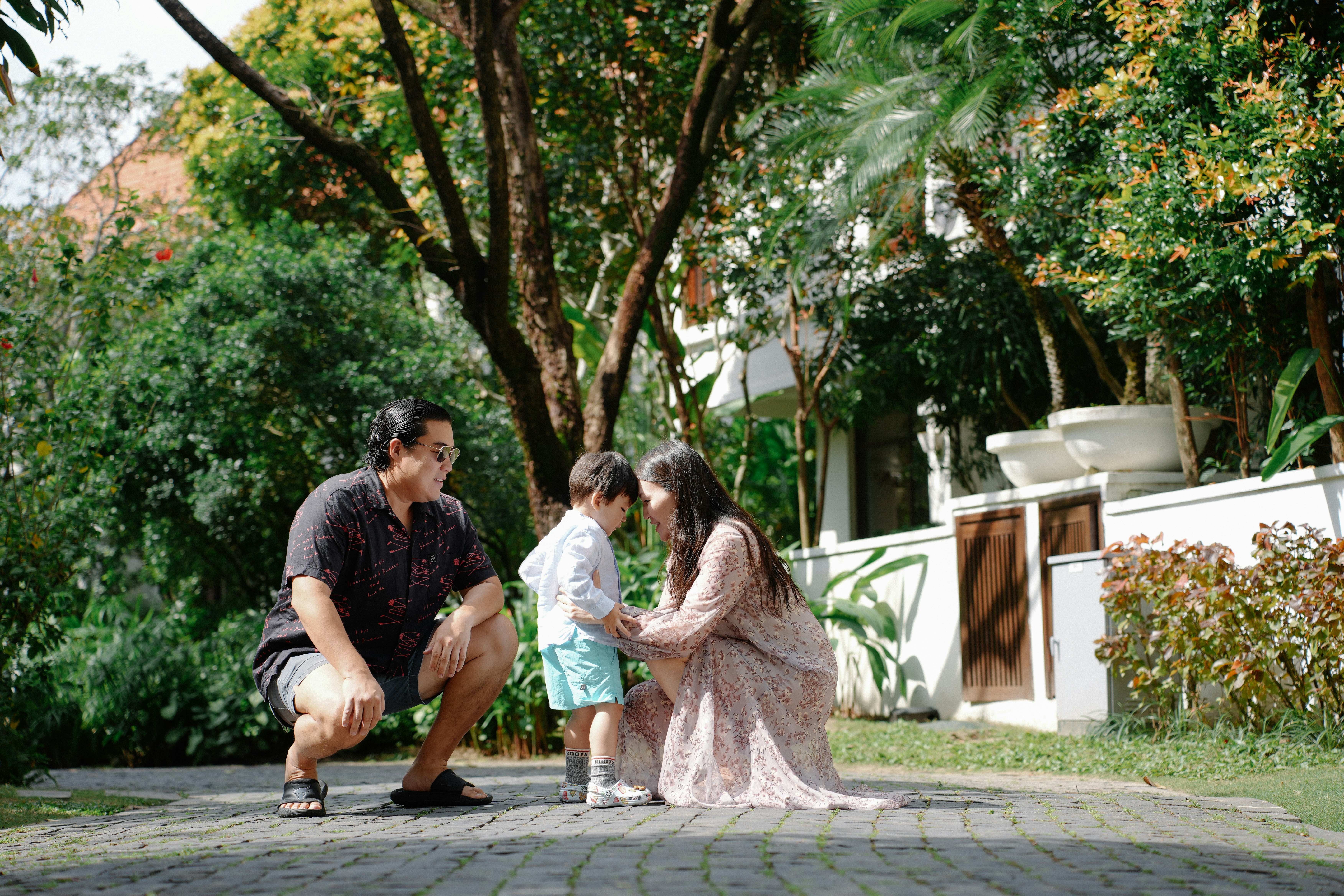 Family interacting in a lush outdoor garden setting