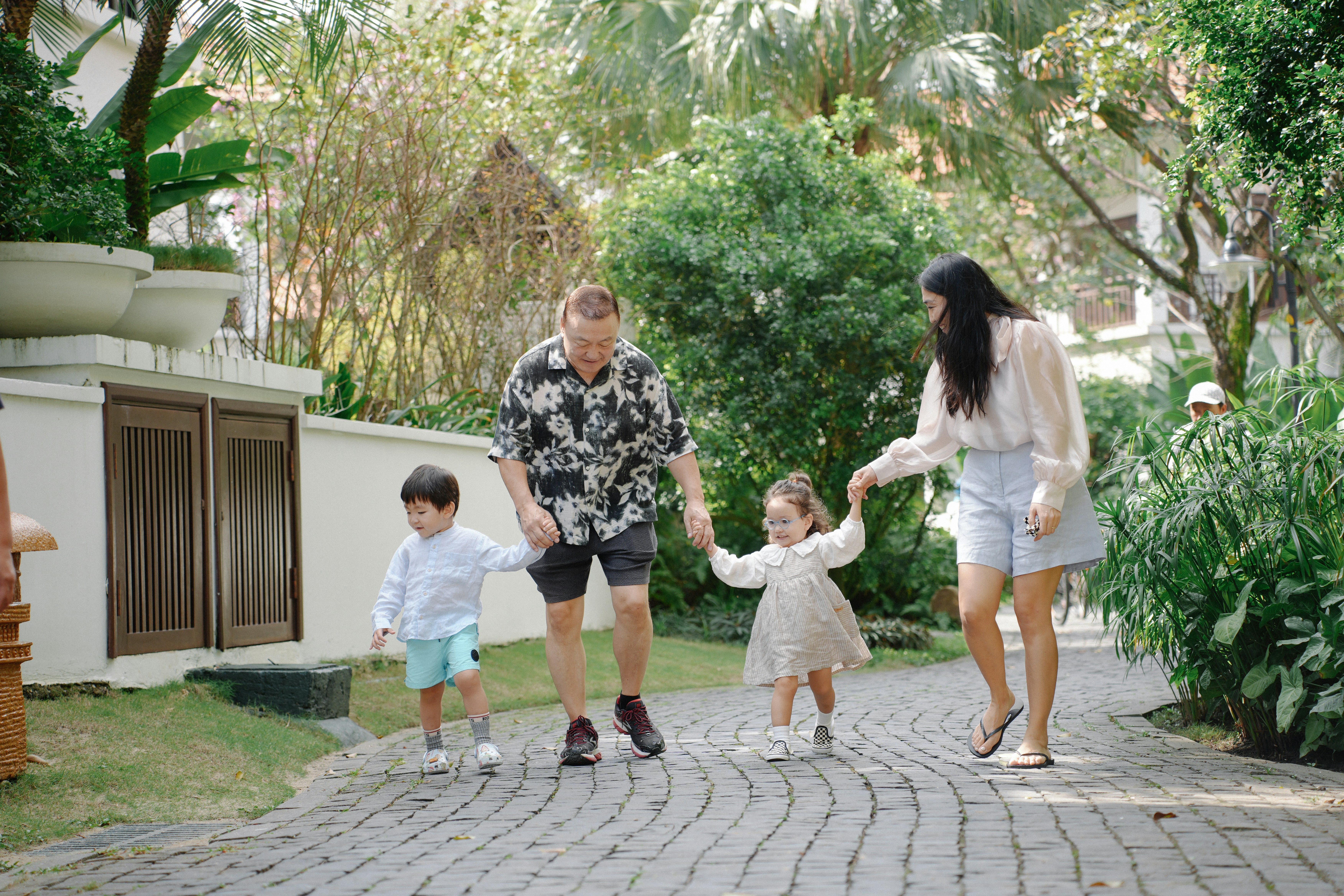 Walking Hand in Hand: a Family Parade Along a Cobblestone Path