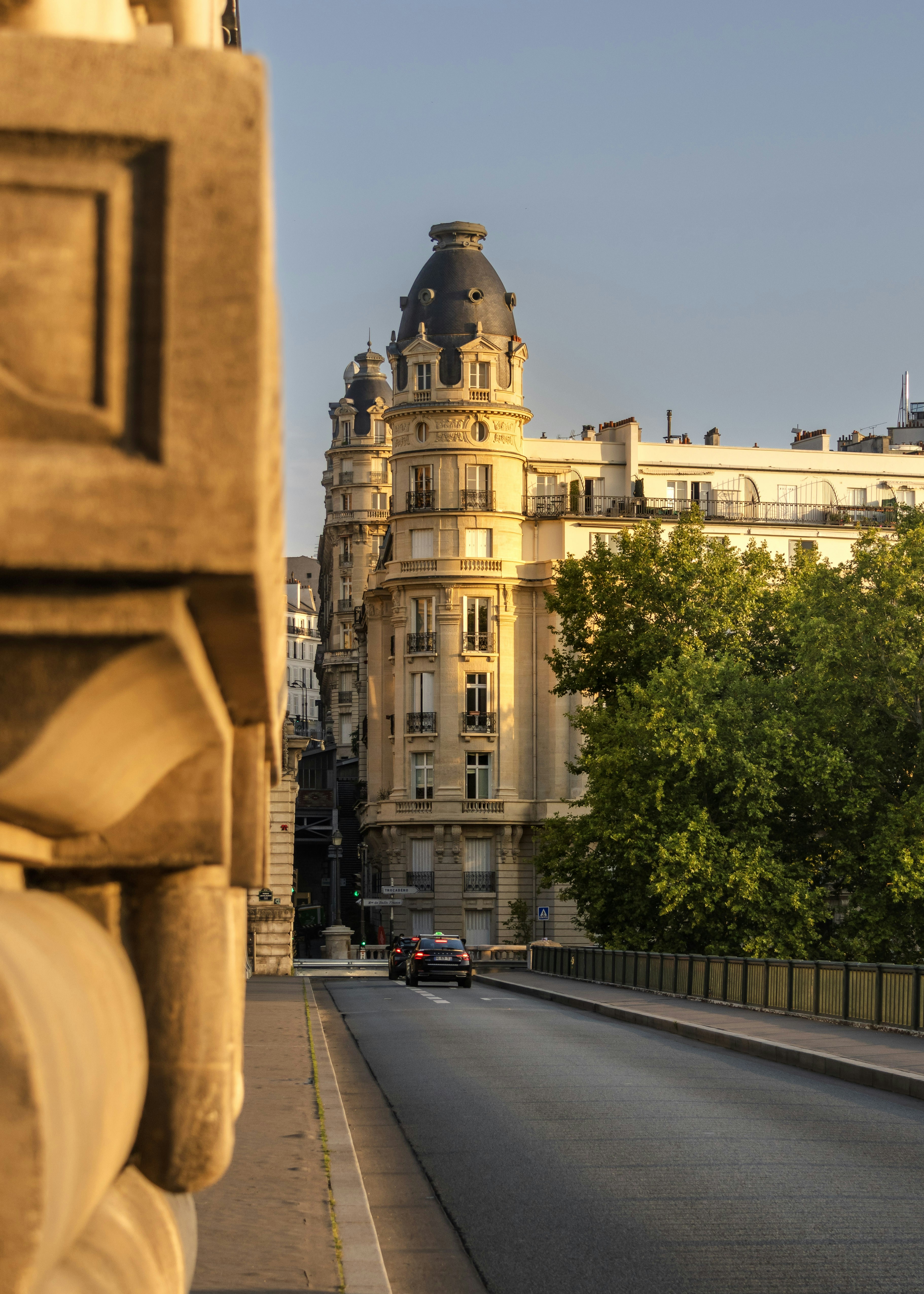 Golden Hour Facades: A Parisian Street ascends toward a domed mansard tower