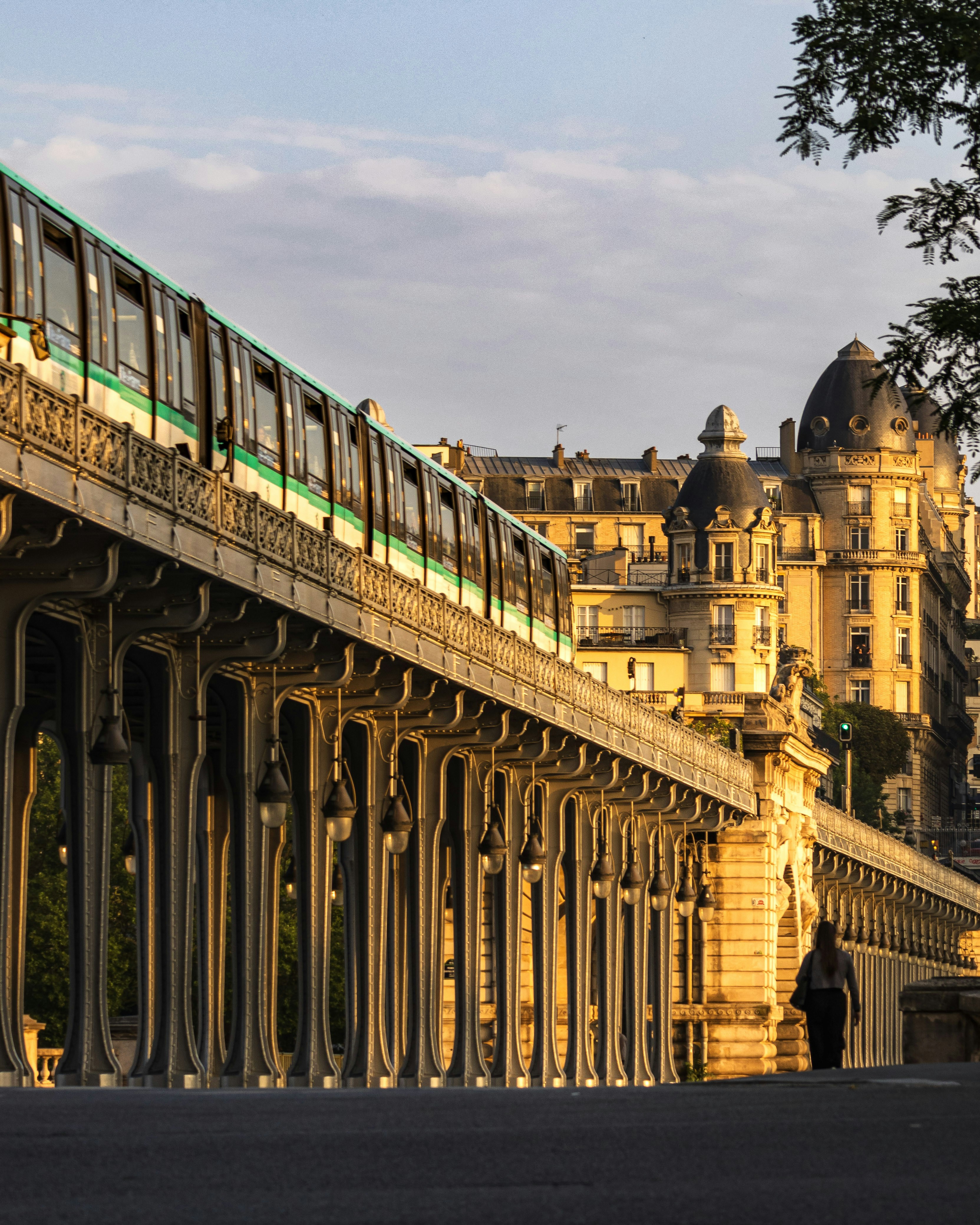 Golden Hour under the Rails: A City Train Rests on a Historic Viaduct