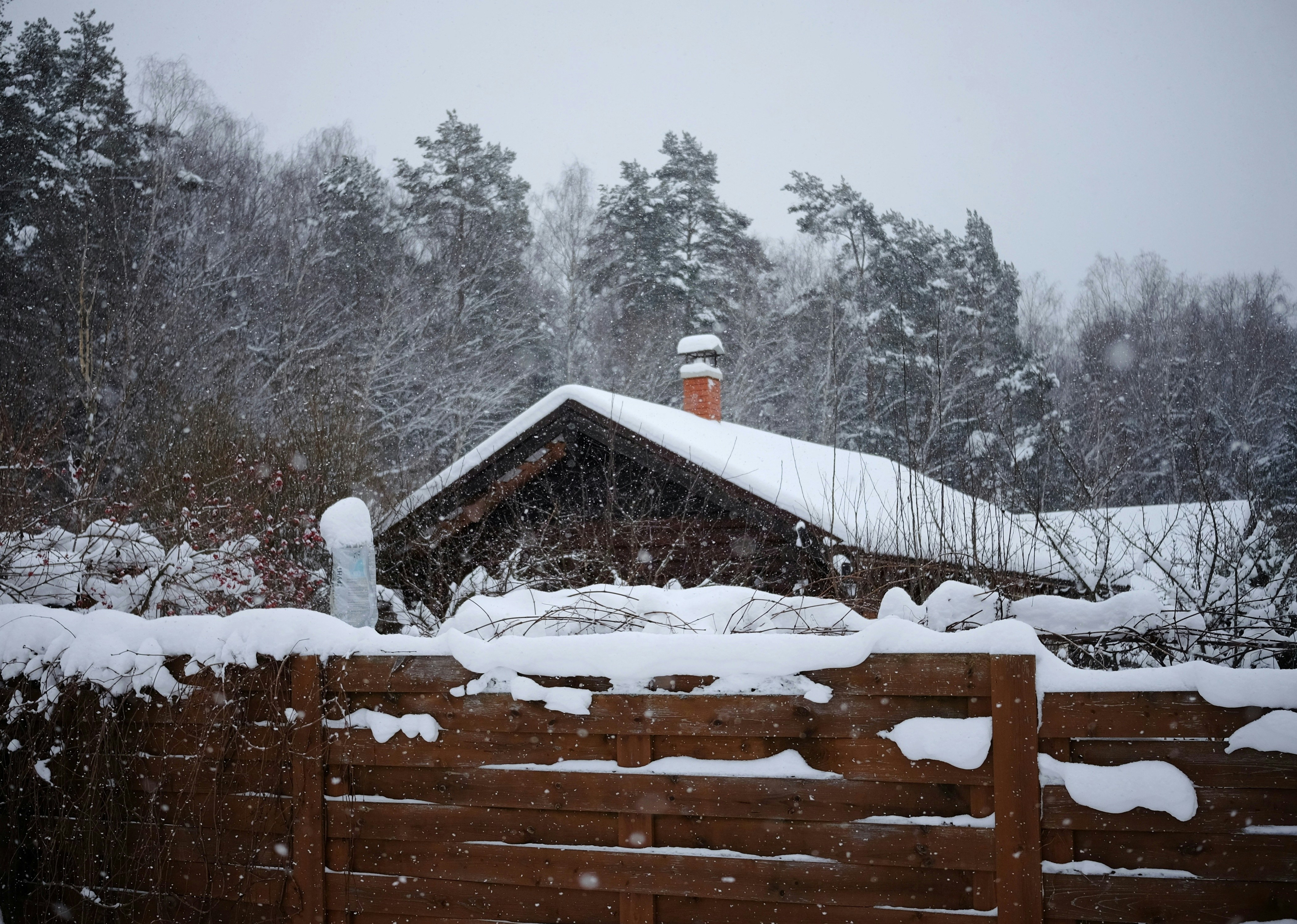 Snowy Ridge Behind a Wooden Fence