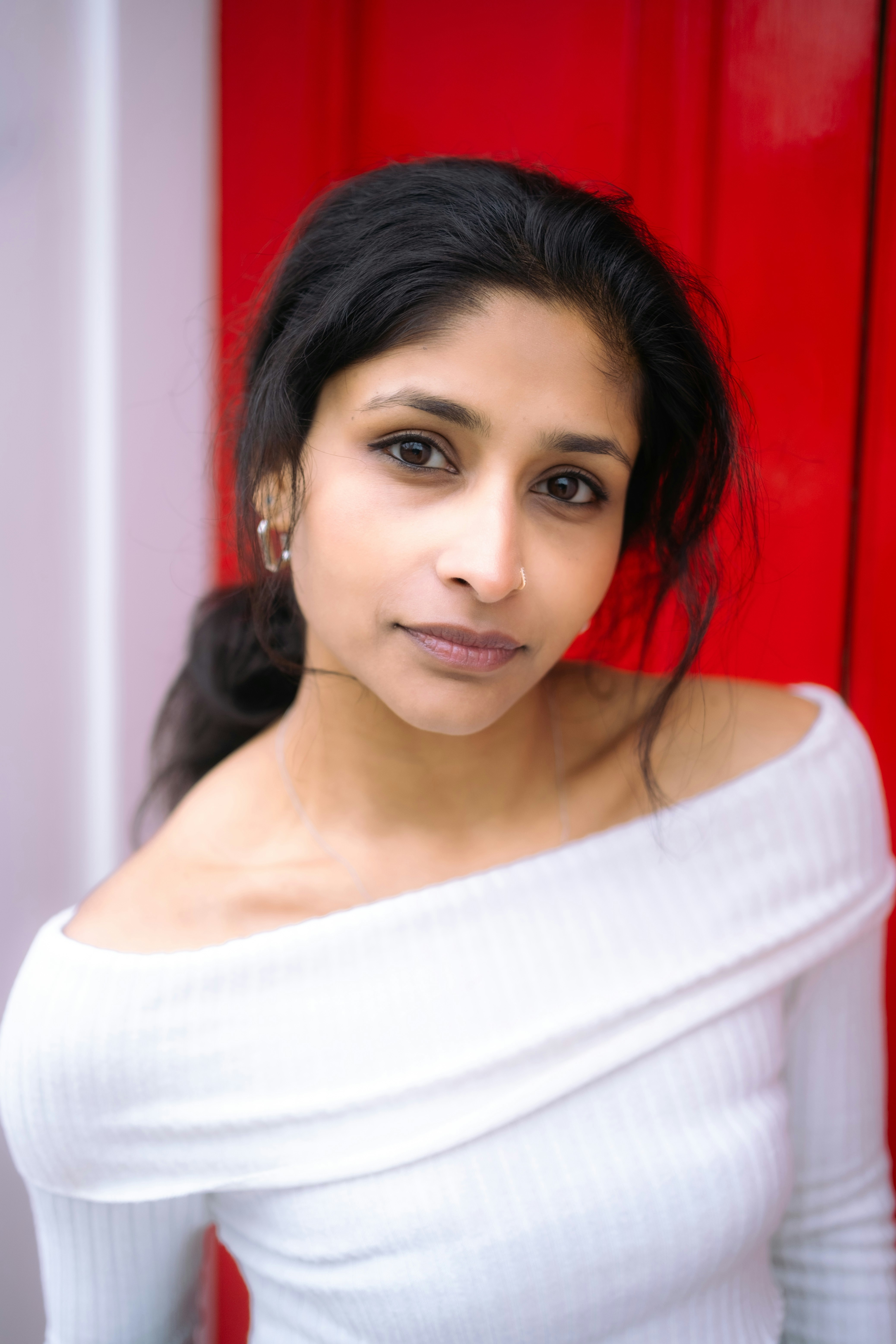 Portrait in Red: A Gentle Gaze Across a Velvet Door