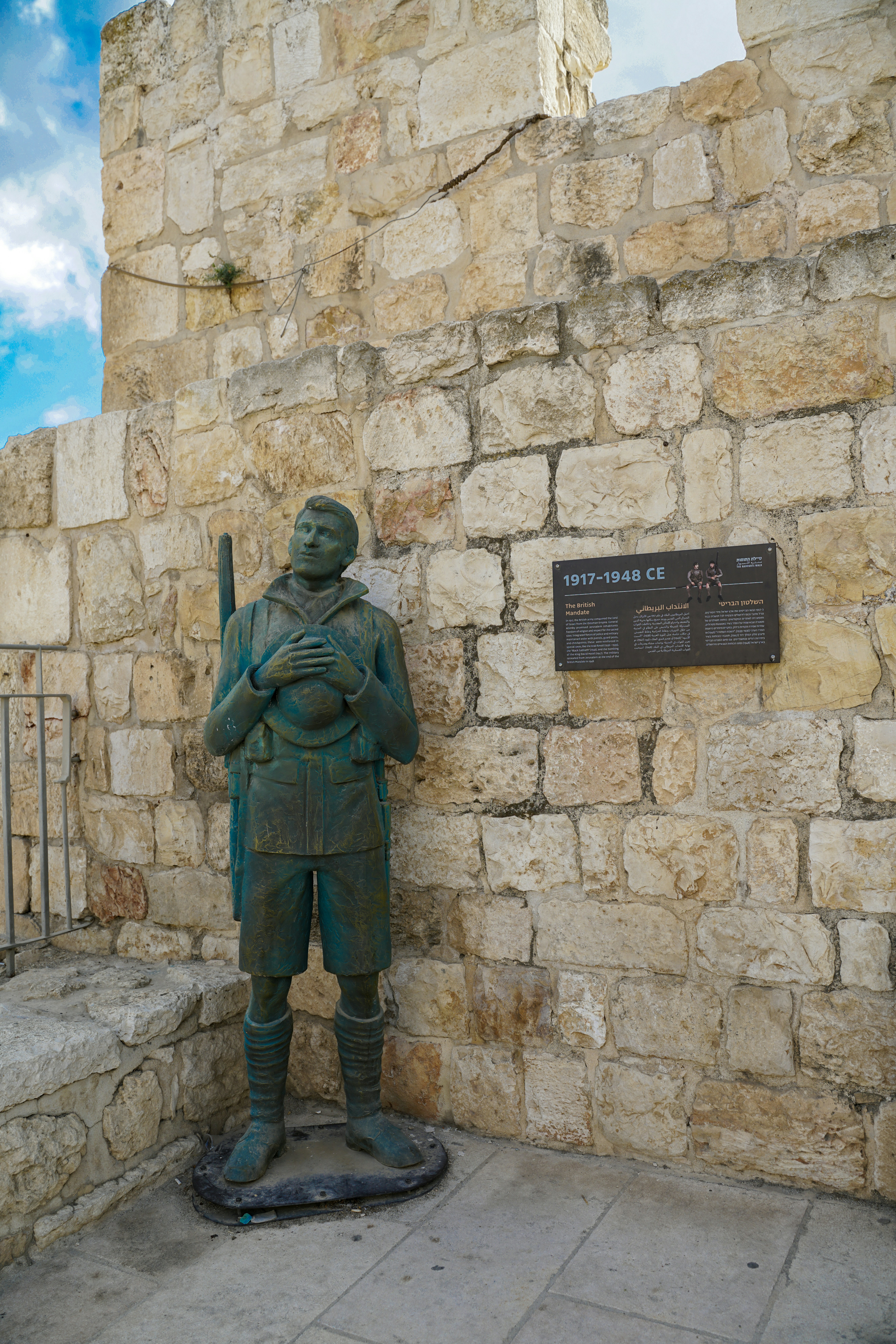 Bronze Scout Stance Before a Historic Wall