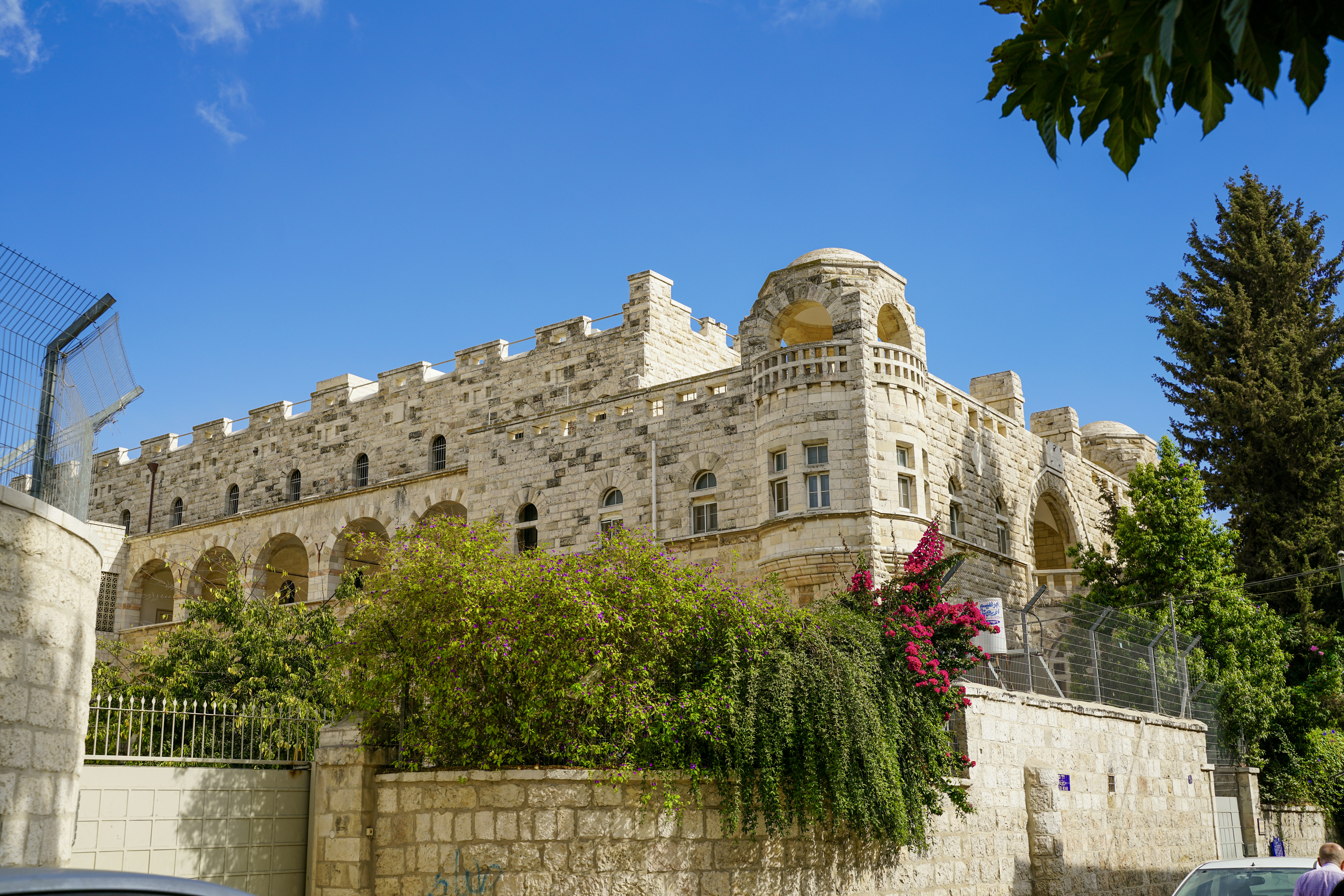 Stone building with arched windows and trees. photo – Free Balcony ...