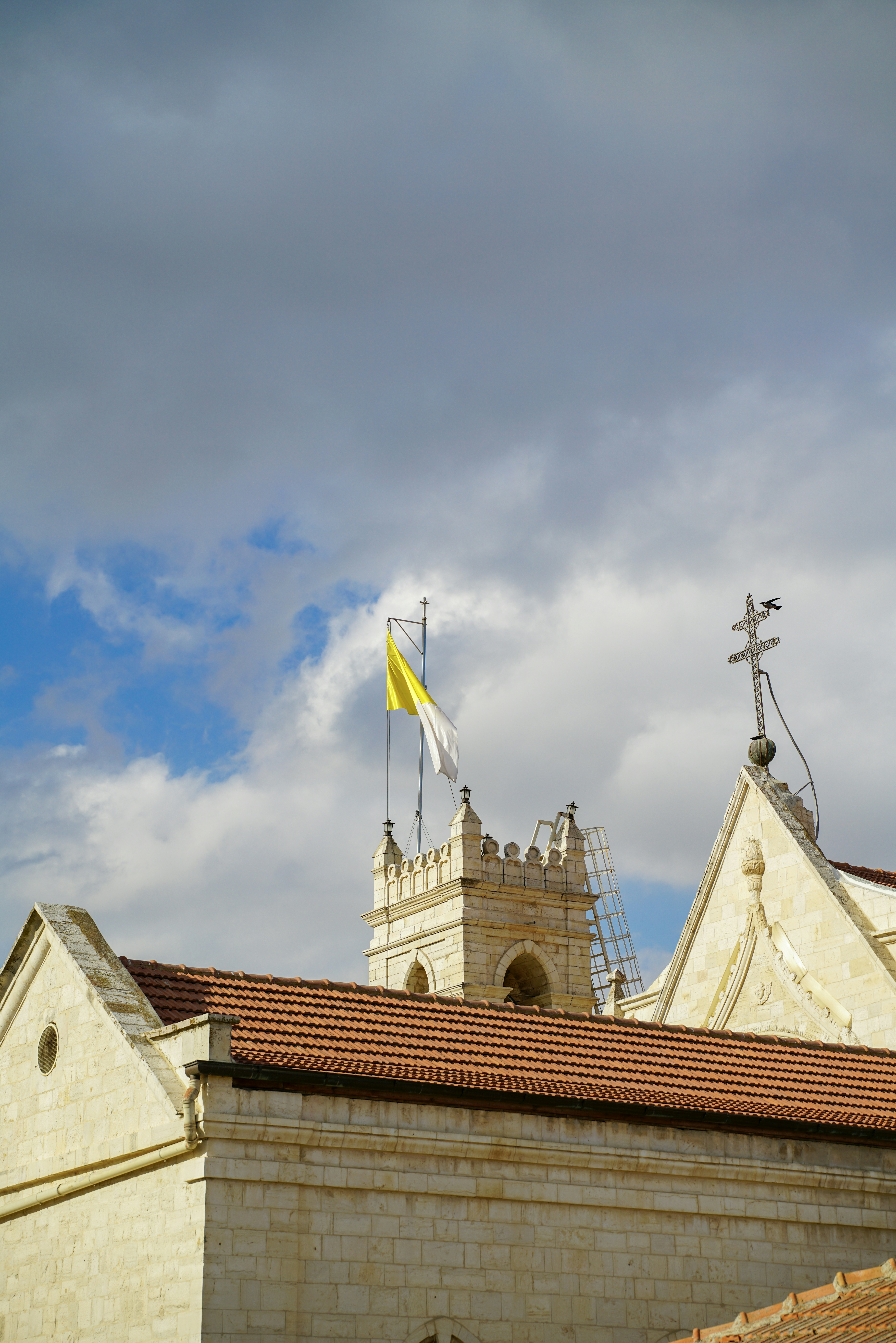 Stone Crown: A Church Roof Under a Sky of Contrasting Light