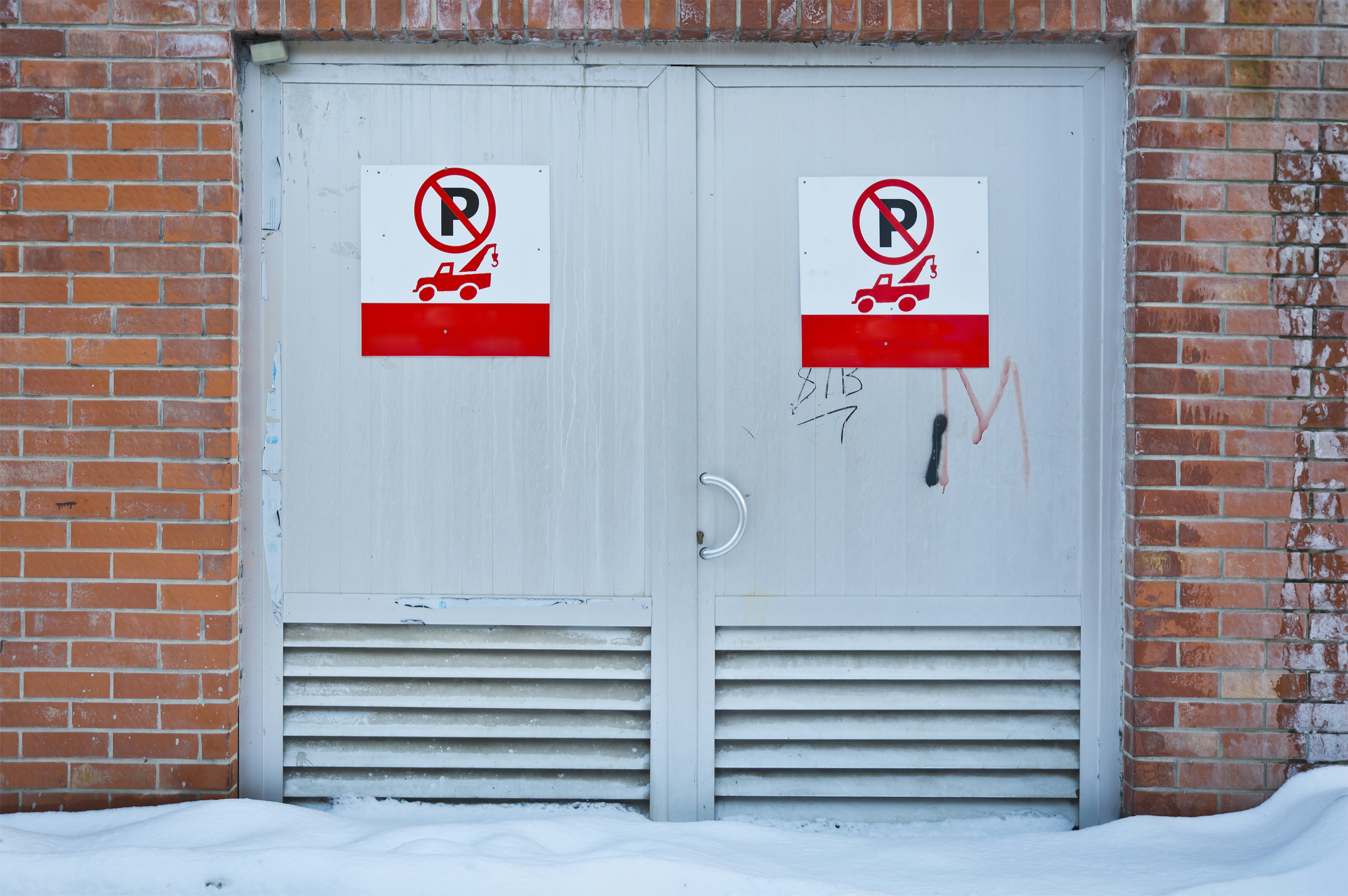 Snow at the No-Exit Gate: Dim Door Panels with Parking Signs