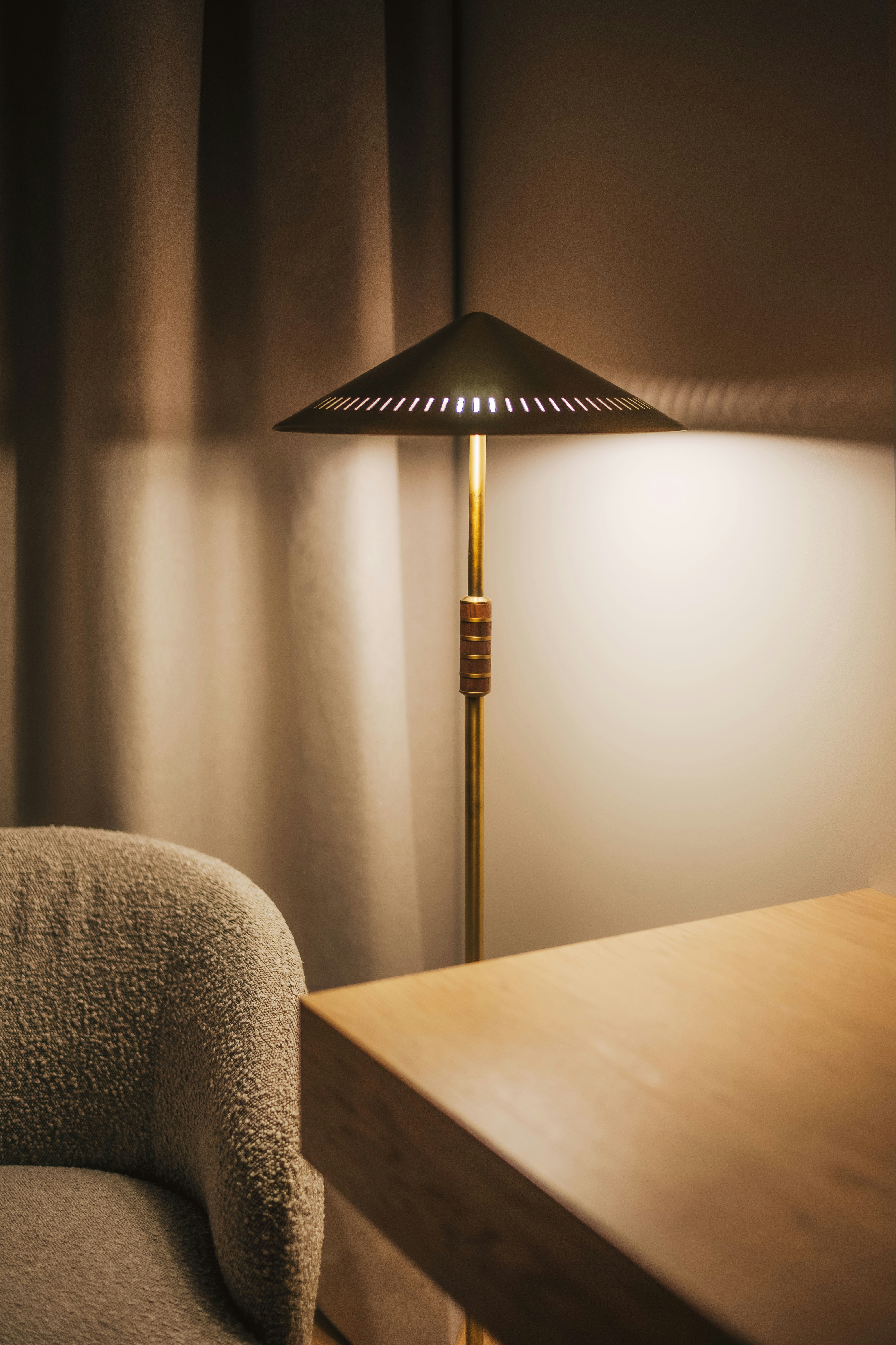 Orbital Glow: A Cozy Corner Lit by a Brass-Top Floor Lamp