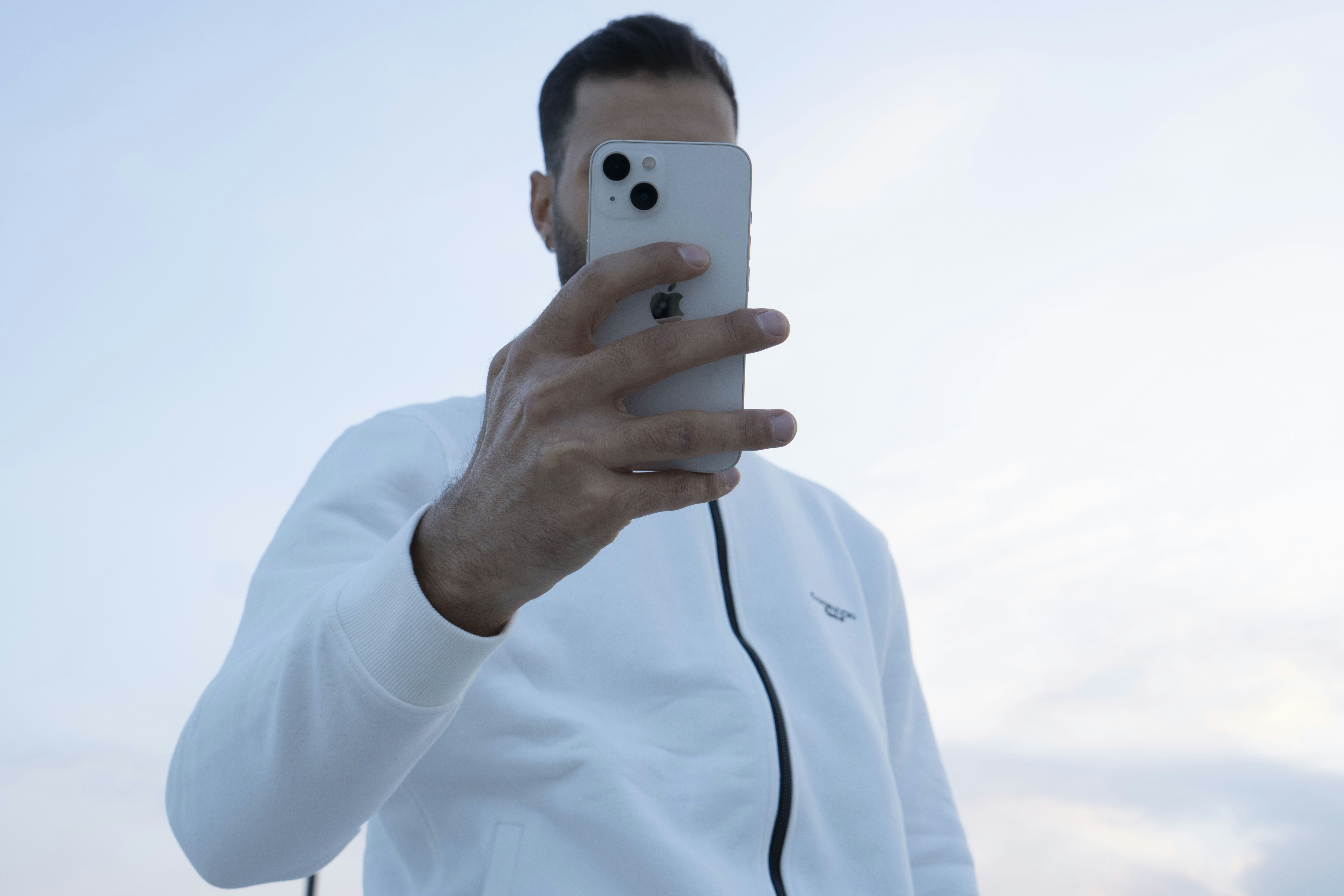 Phone Check: A Close-Up Selfie Moment in Soft Evening Light