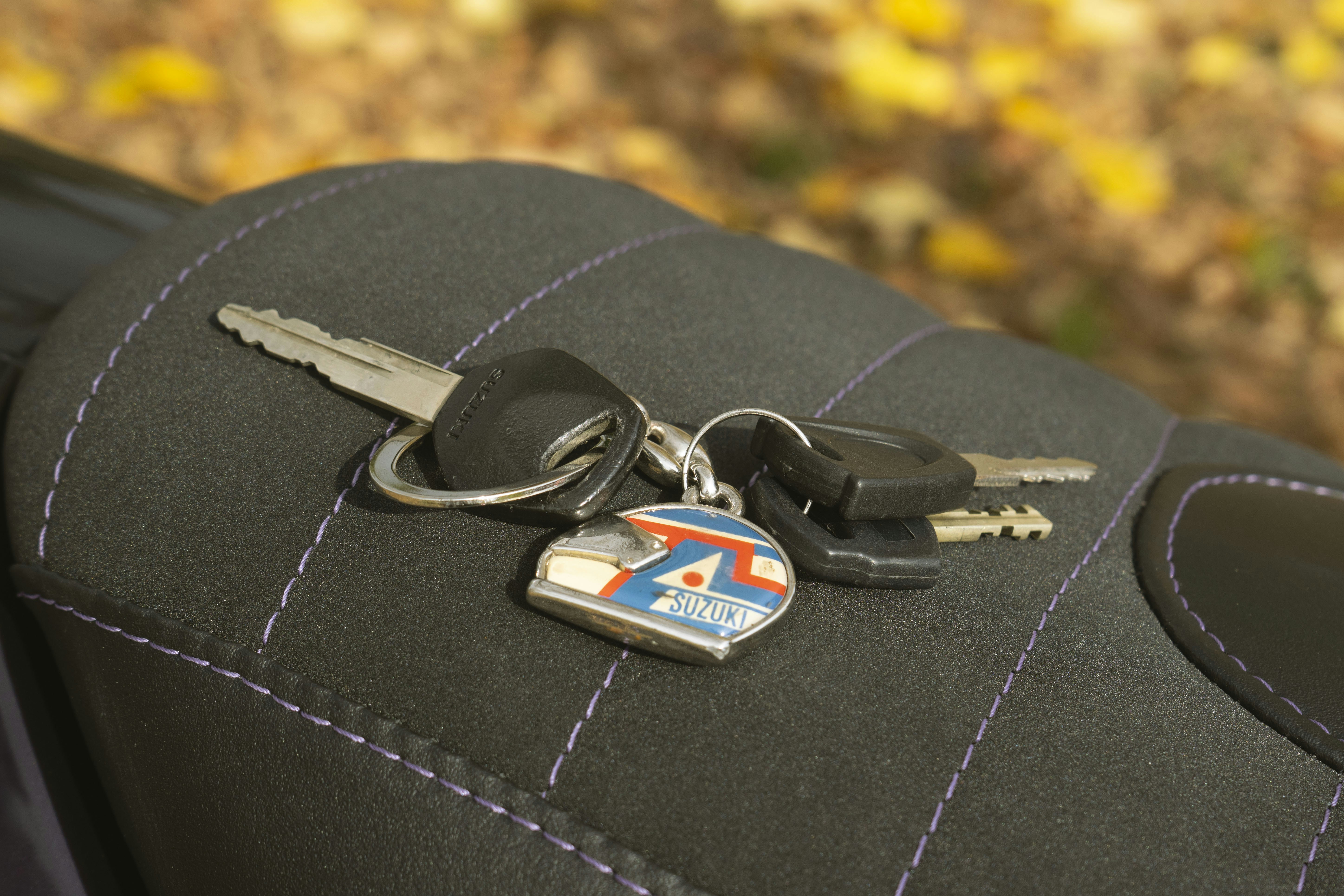 Keychain on a motorcycle seat: Silver Keys with Suzuki Emblem