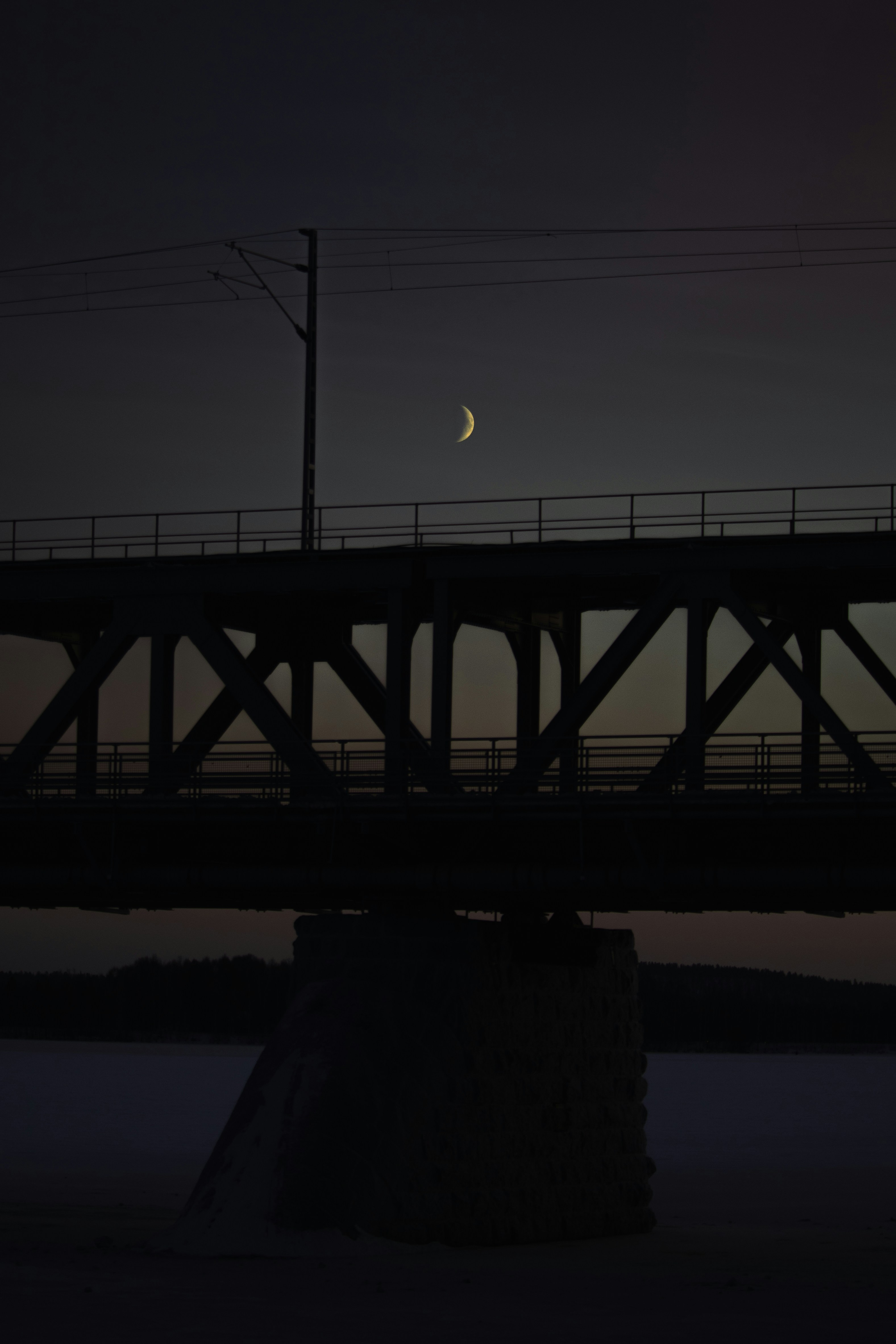 Moonlit Rail Bridge in Dusk: A Quiet Silhouette