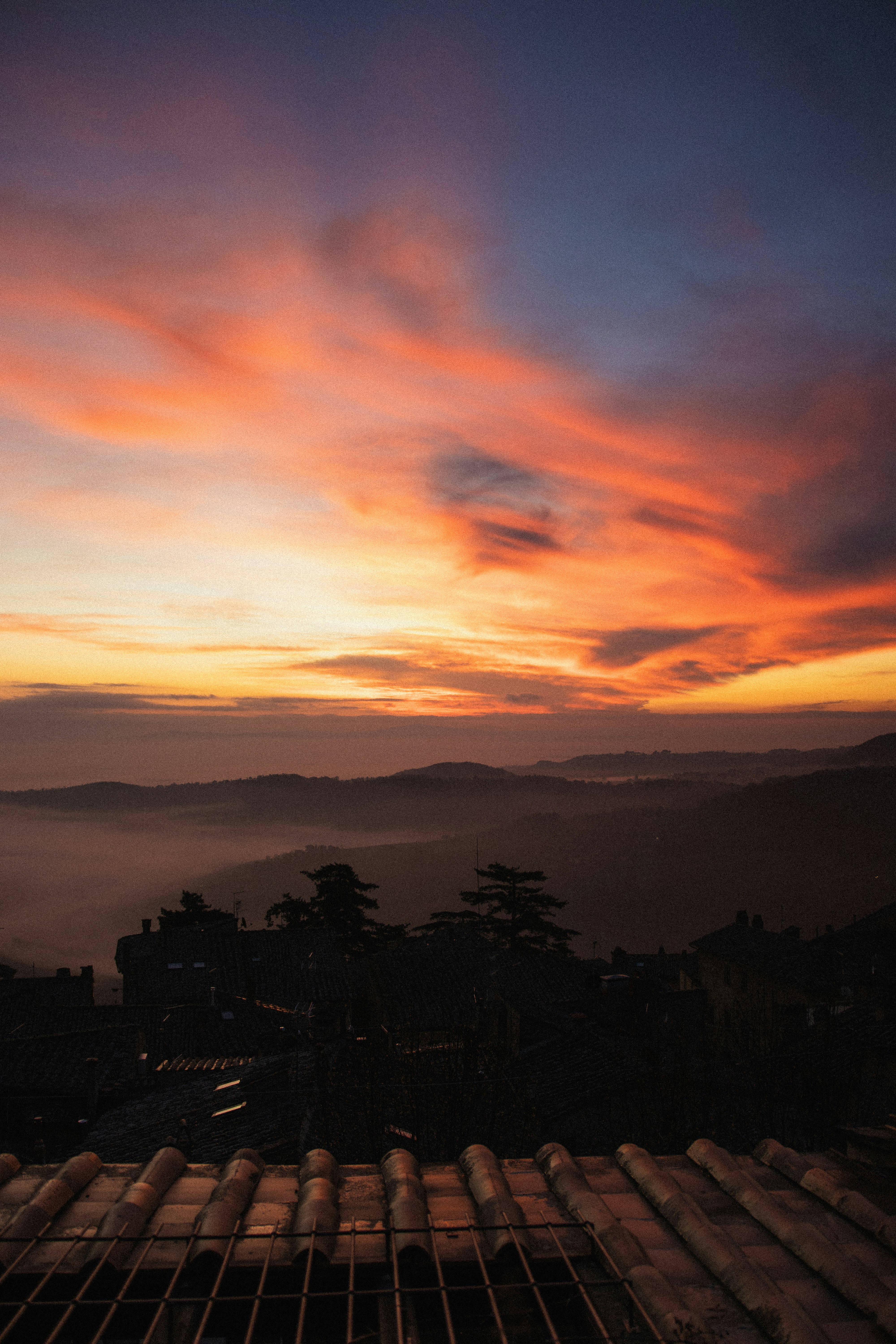 Dusk Over Fog-Laced Rooftops and Velvet Hills