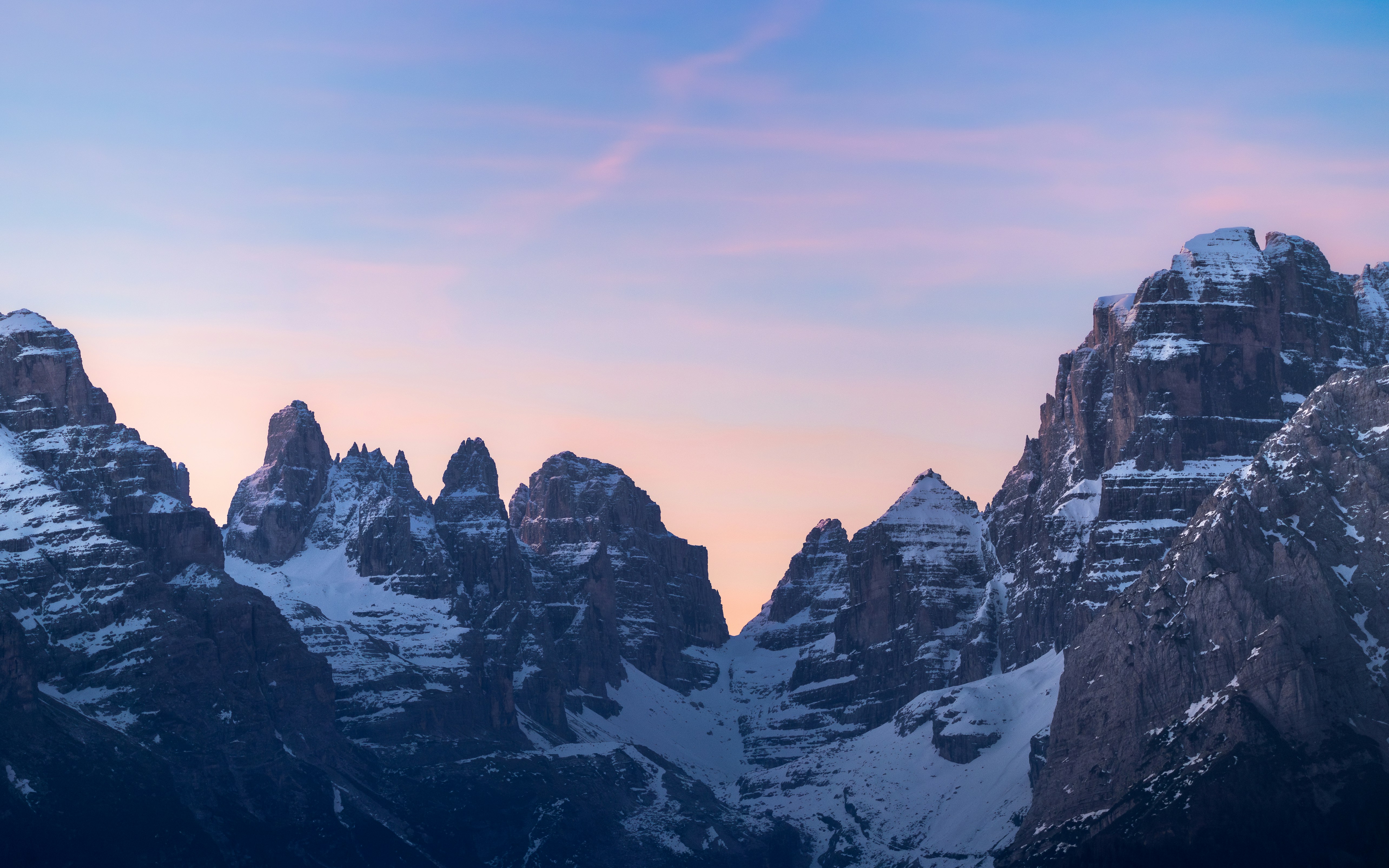 Snow-capped mountains under a pastel skyMarek Piwnicki