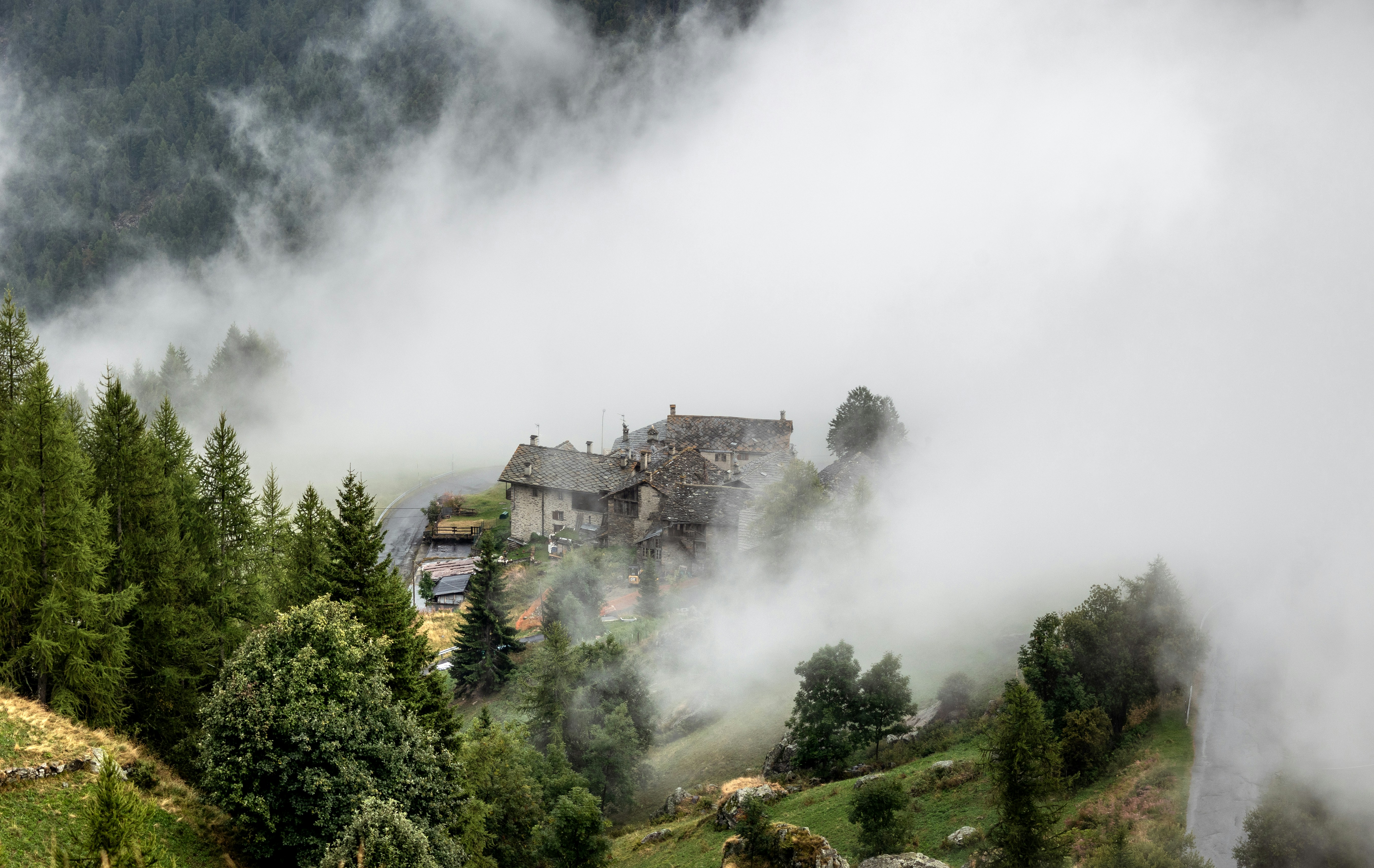 Stone building nestled in foggy mountain forestMarek Piwnicki