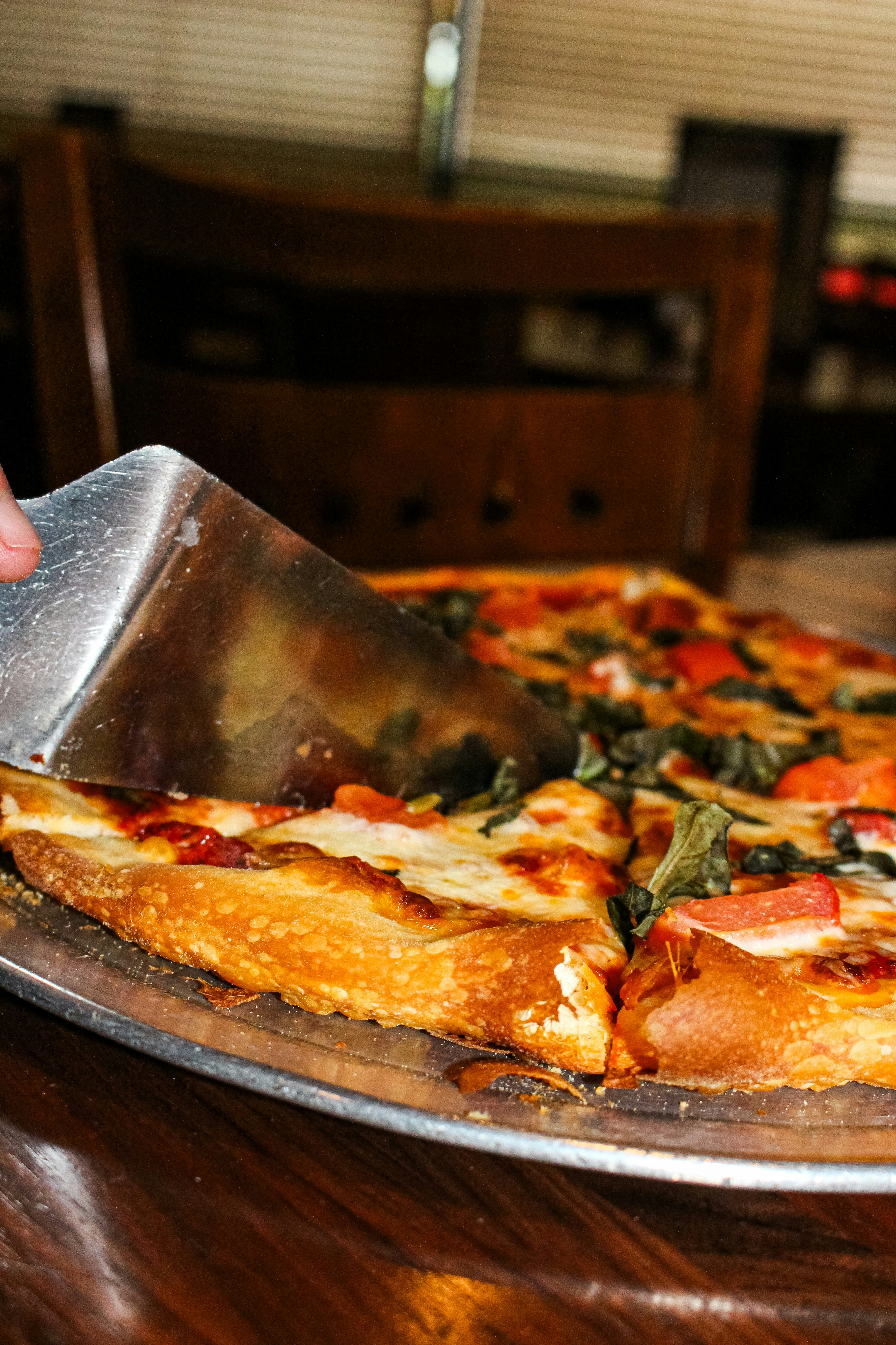 Slice of Comfort: Pepperoni, Basil, and Melted Cheese on a Rustic Pie