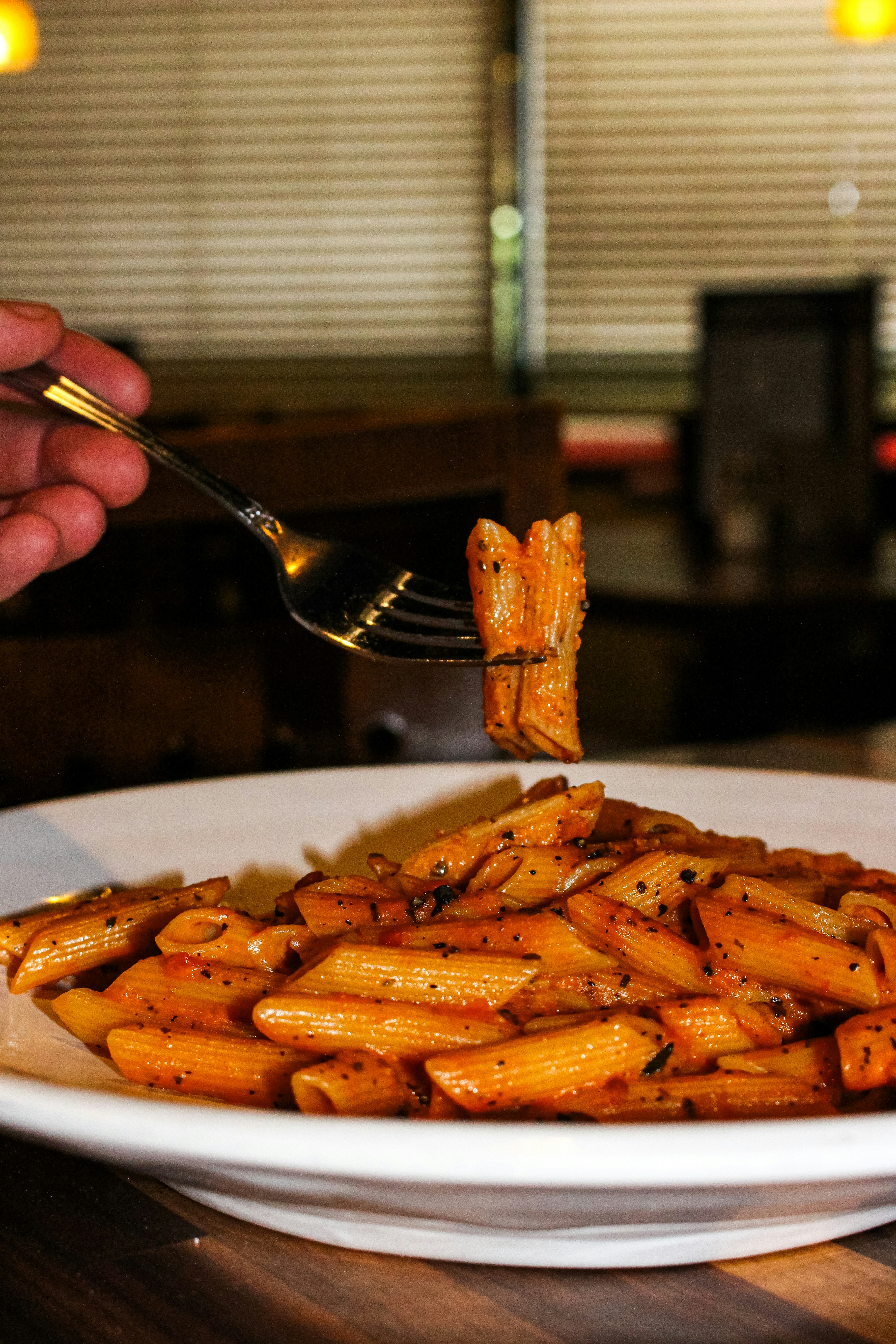 Forkful of Pasta: A Glimpse of Texture and Toasted Pepper