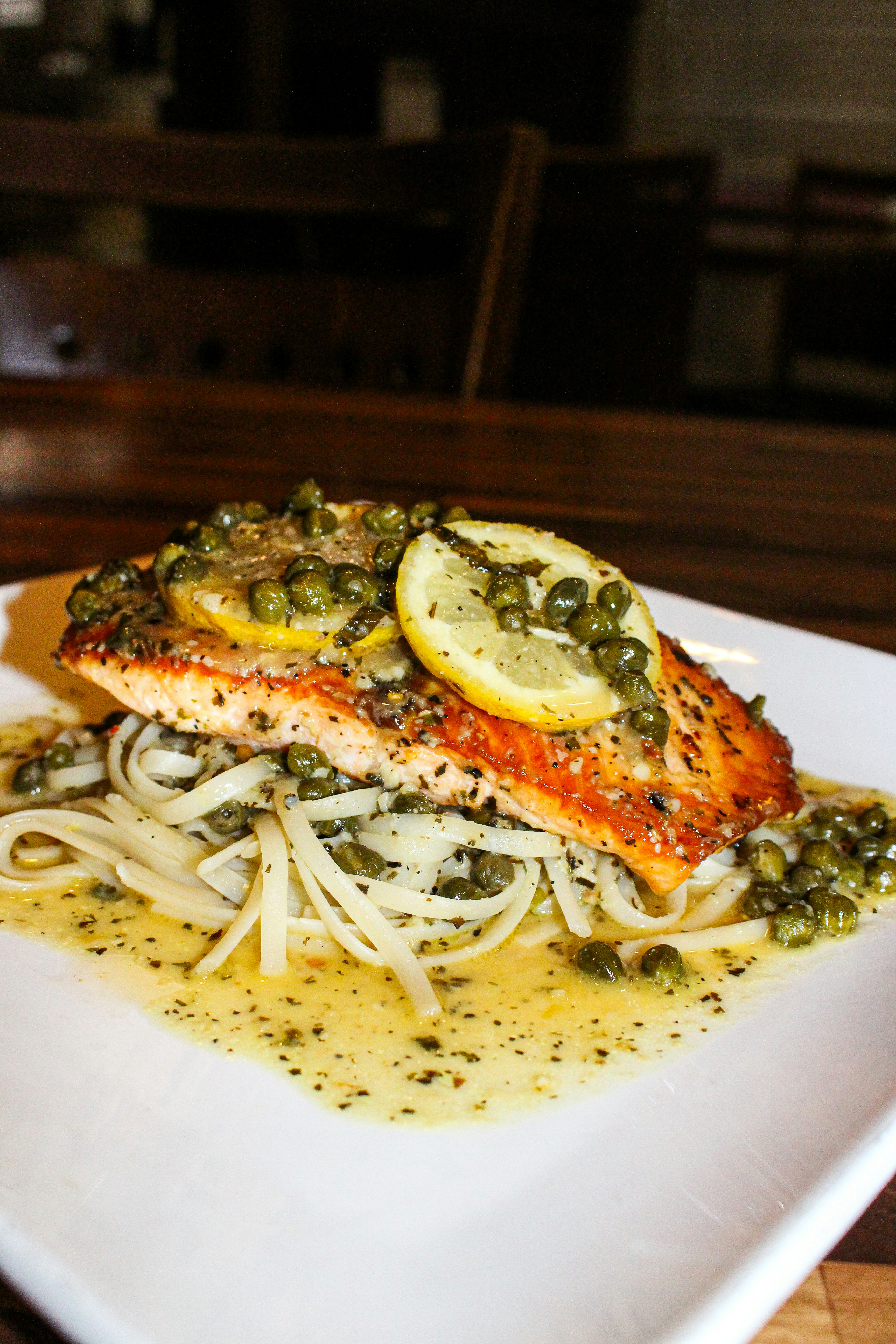 Lemon-caper Salmon Resting on a Nest of Pasta