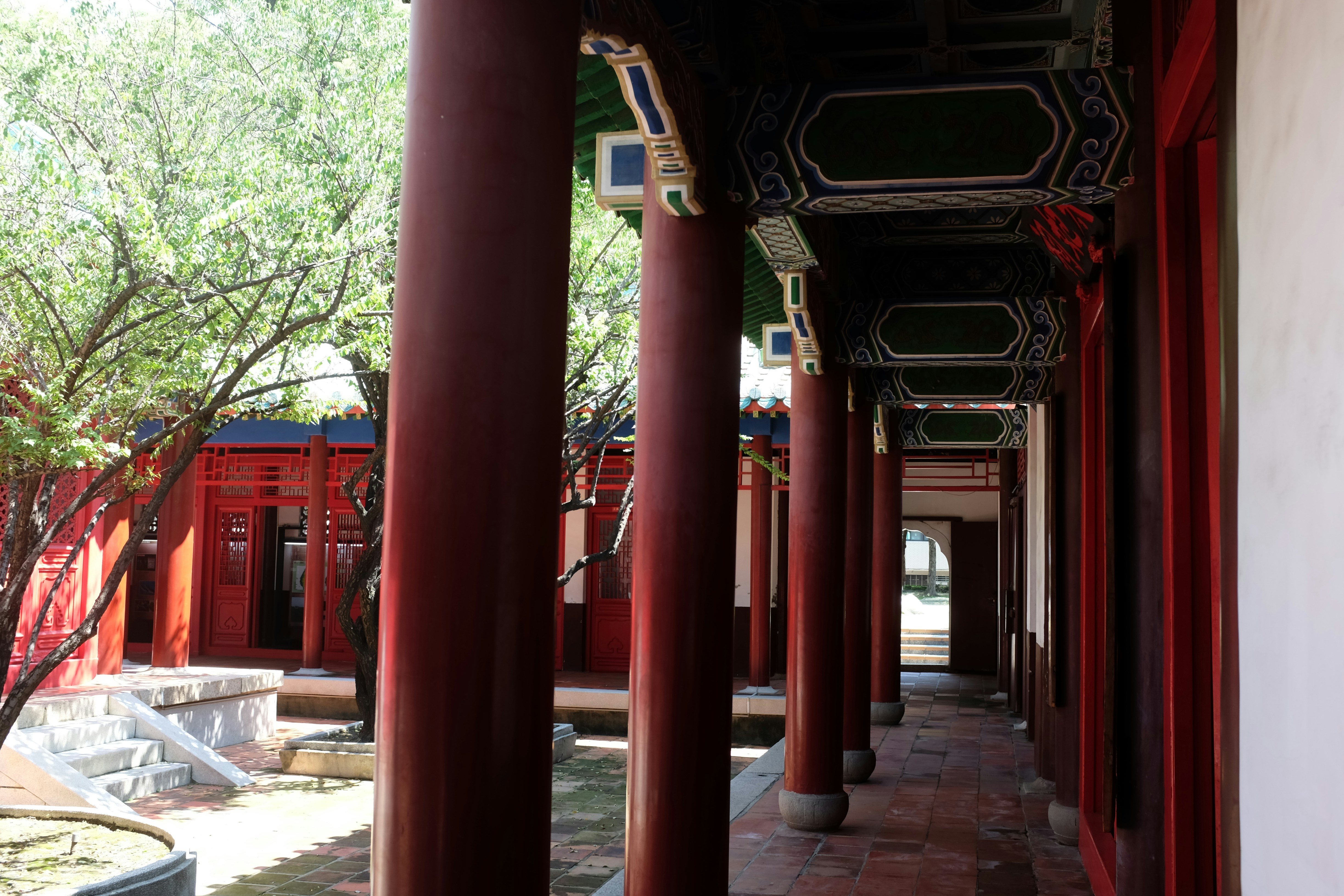 Red Pillars and Shadowed Corridor: Temple Light