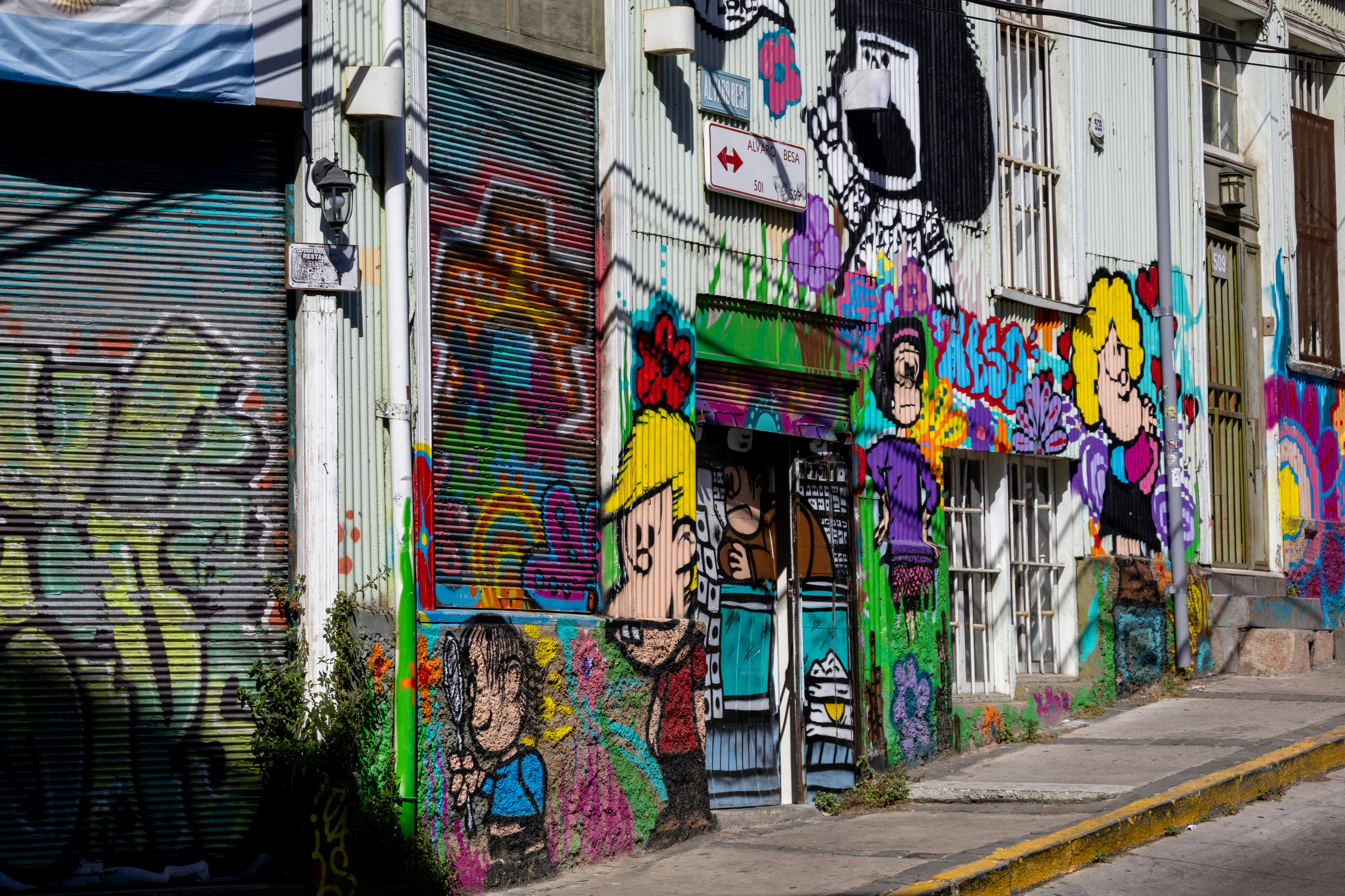 Colorful Street Canvas: A Wall Alive with Graffiti Characters