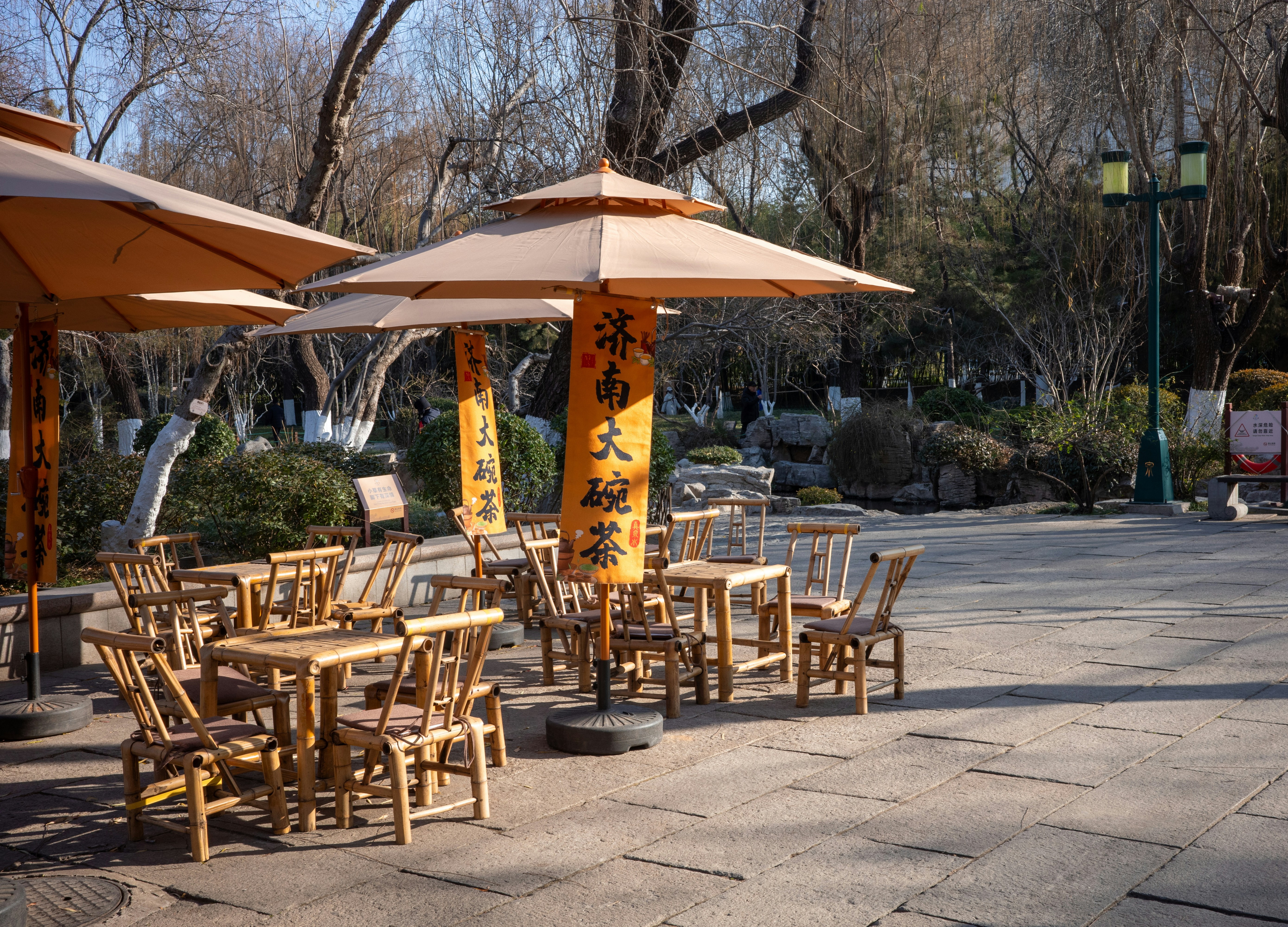 Quiet Courtyard of Wooden Tables under Amber Sunshades