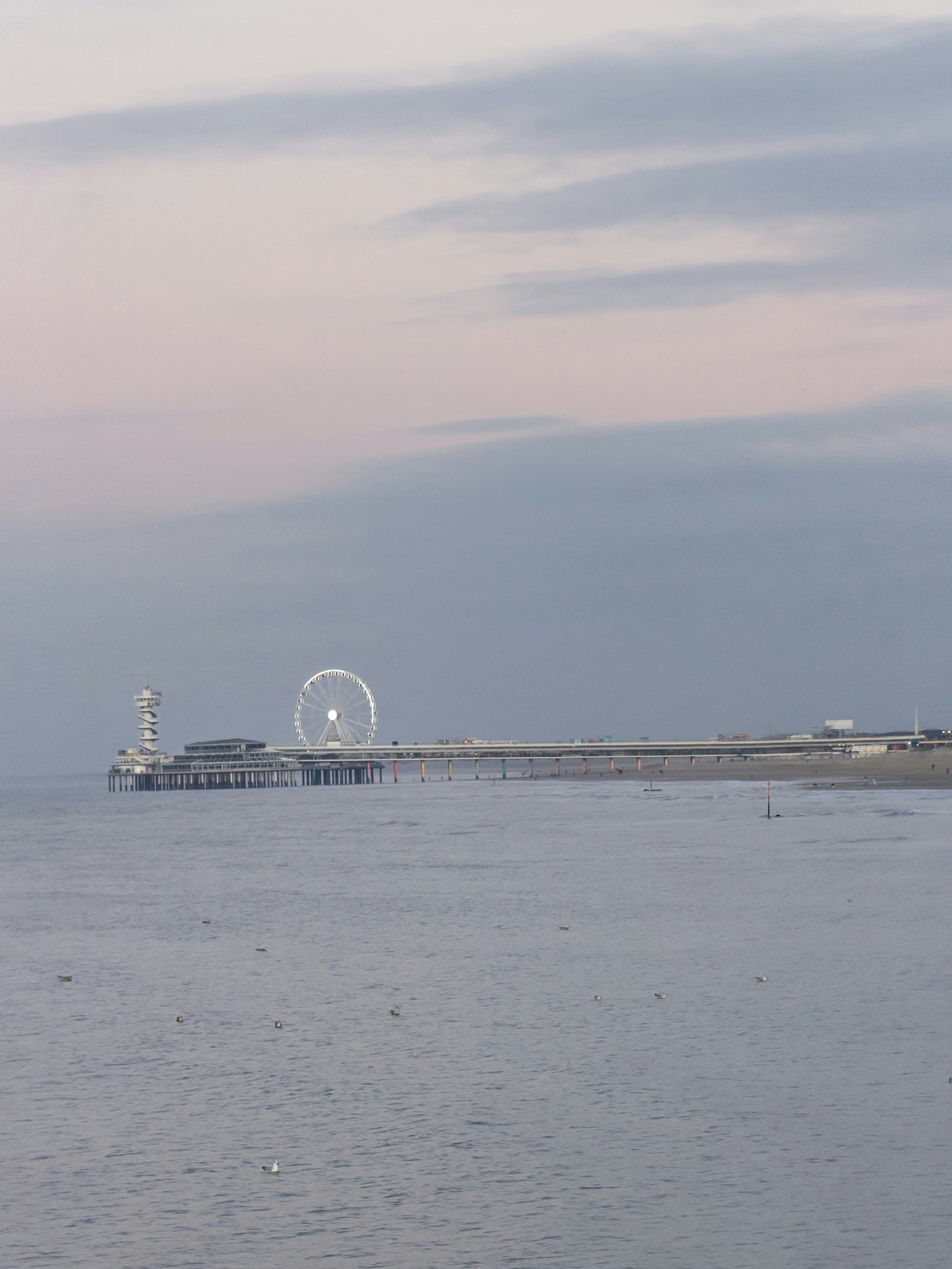 Pastel Pier: A Quiet Sunset Over the Wheel and Sea