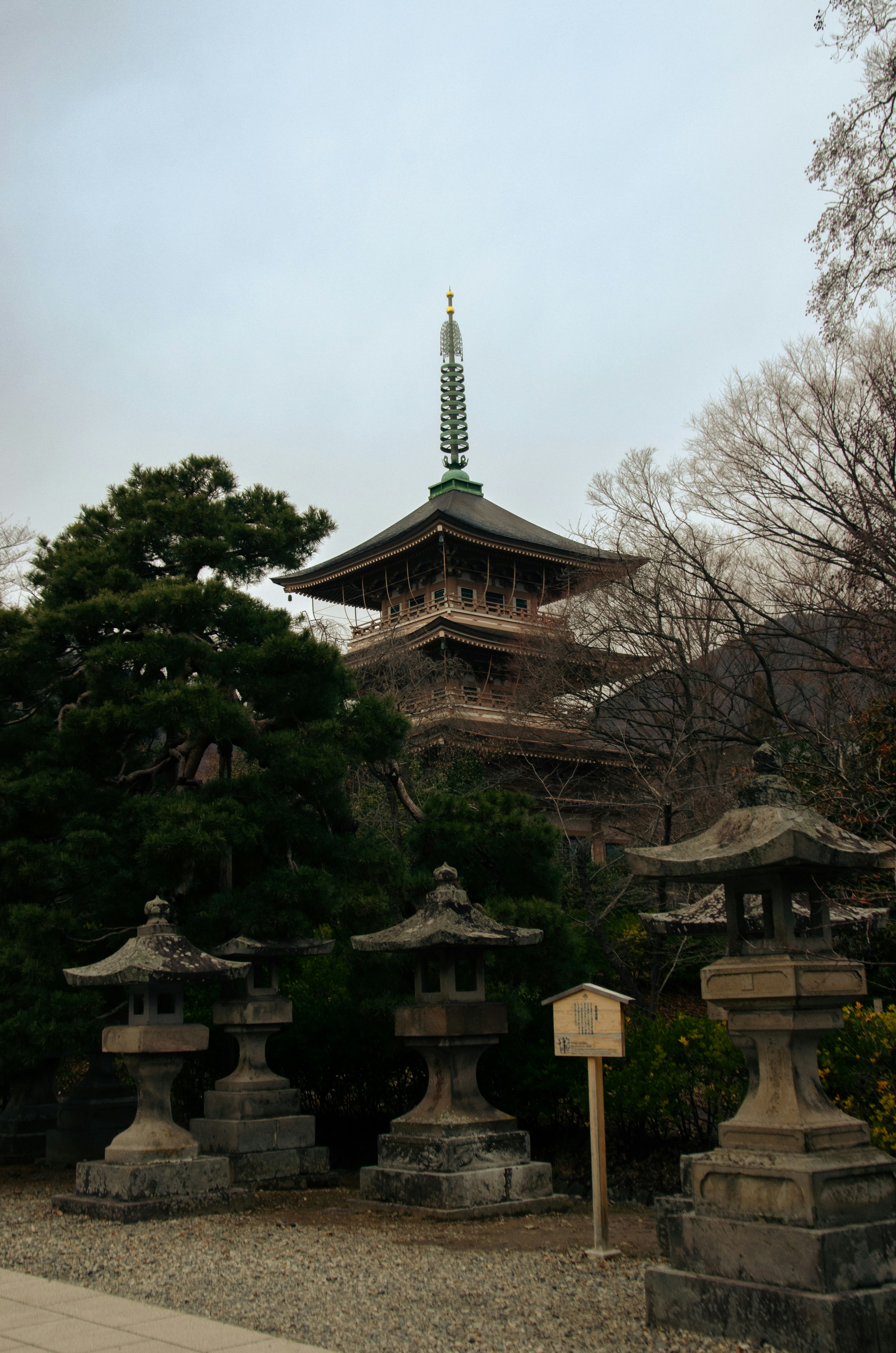 Pagoda Framed by Stone Lanterns and Winter Trees