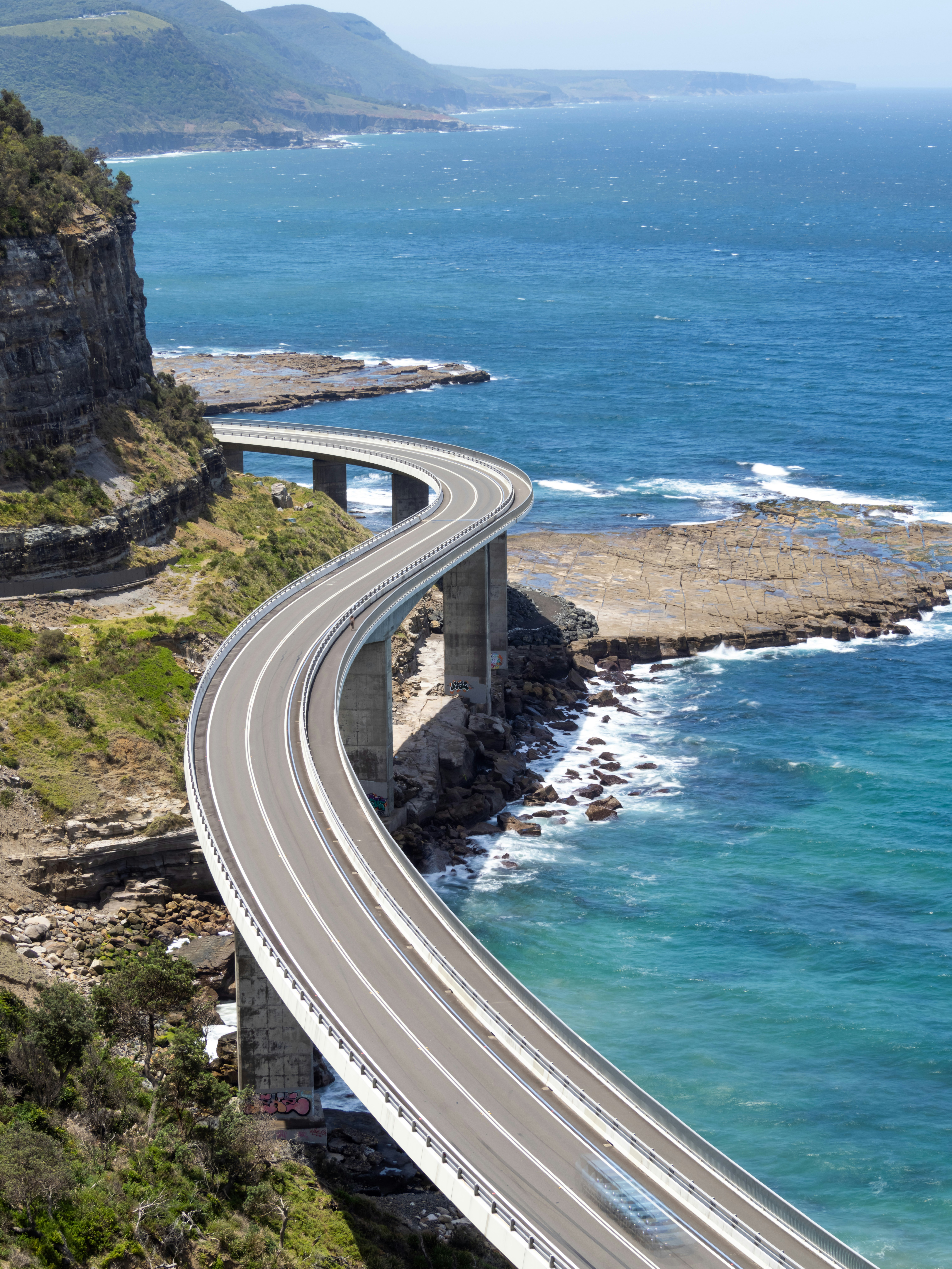 Curving highway bridge over the ocean coastline photo – Free Travel ...