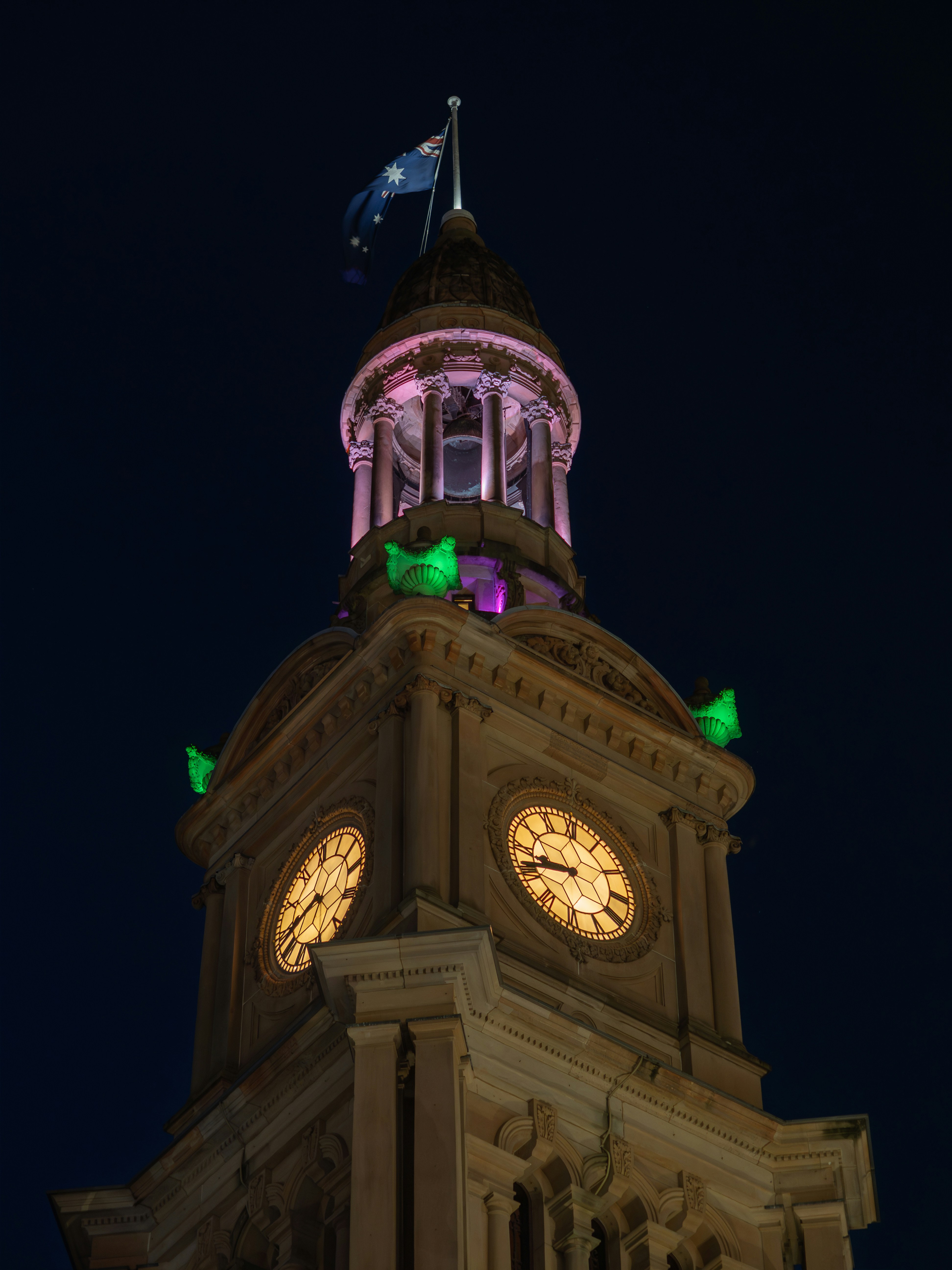 Nighttime Clock Tower Ascends in Neon