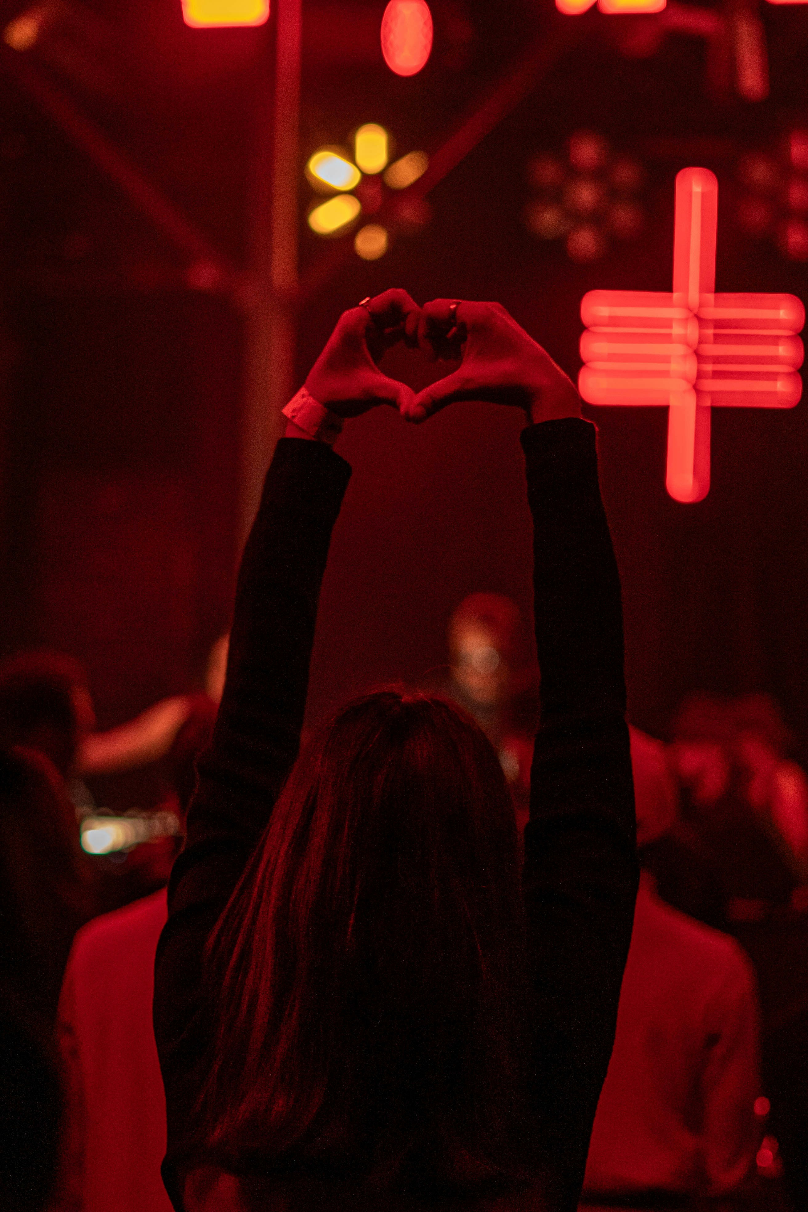 Neon Heartbeat: A Silhouette in Crimson Nightlife