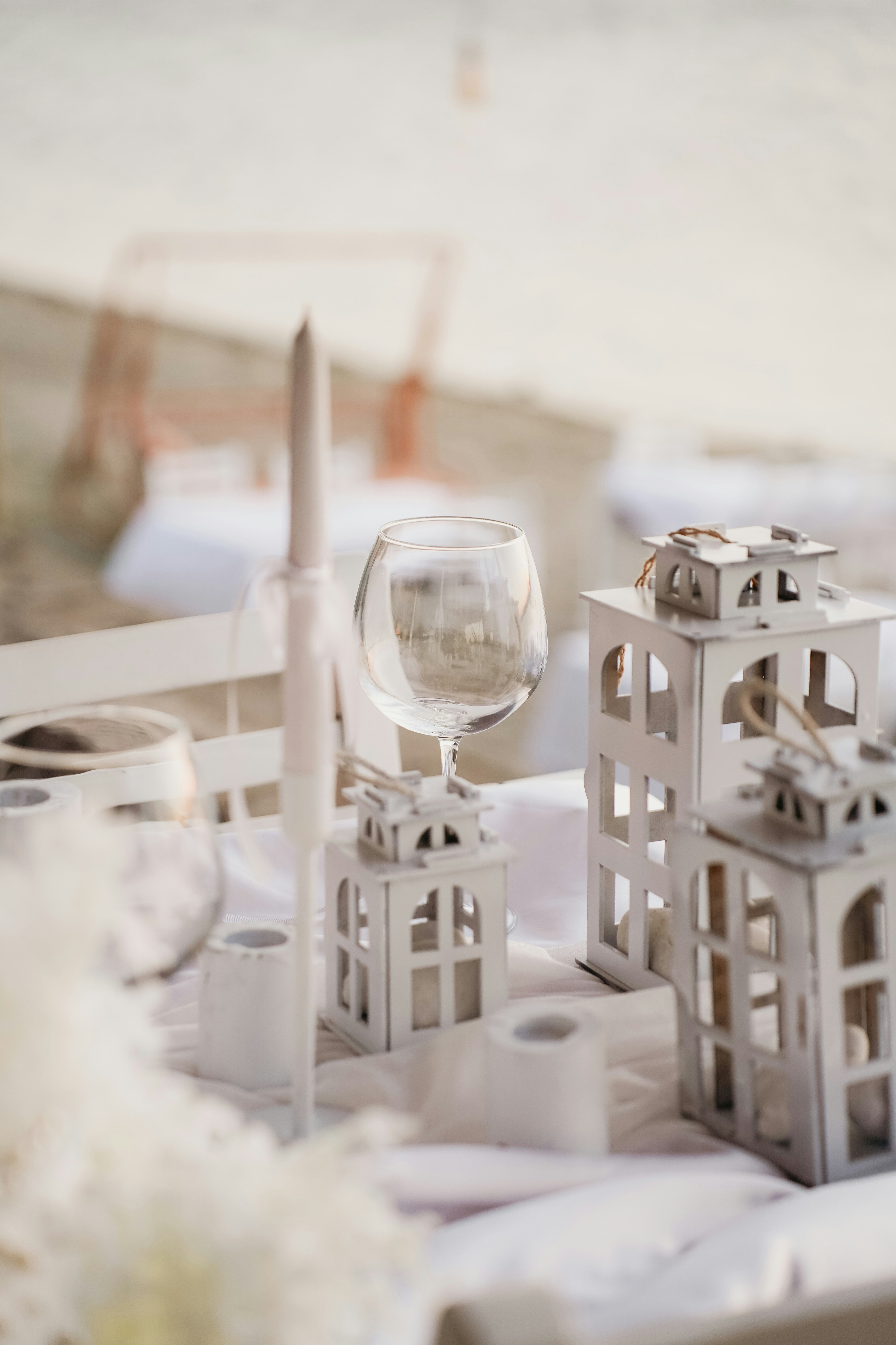 Soft Evening Table: Glassware and Lanterns on a White Tablecloth