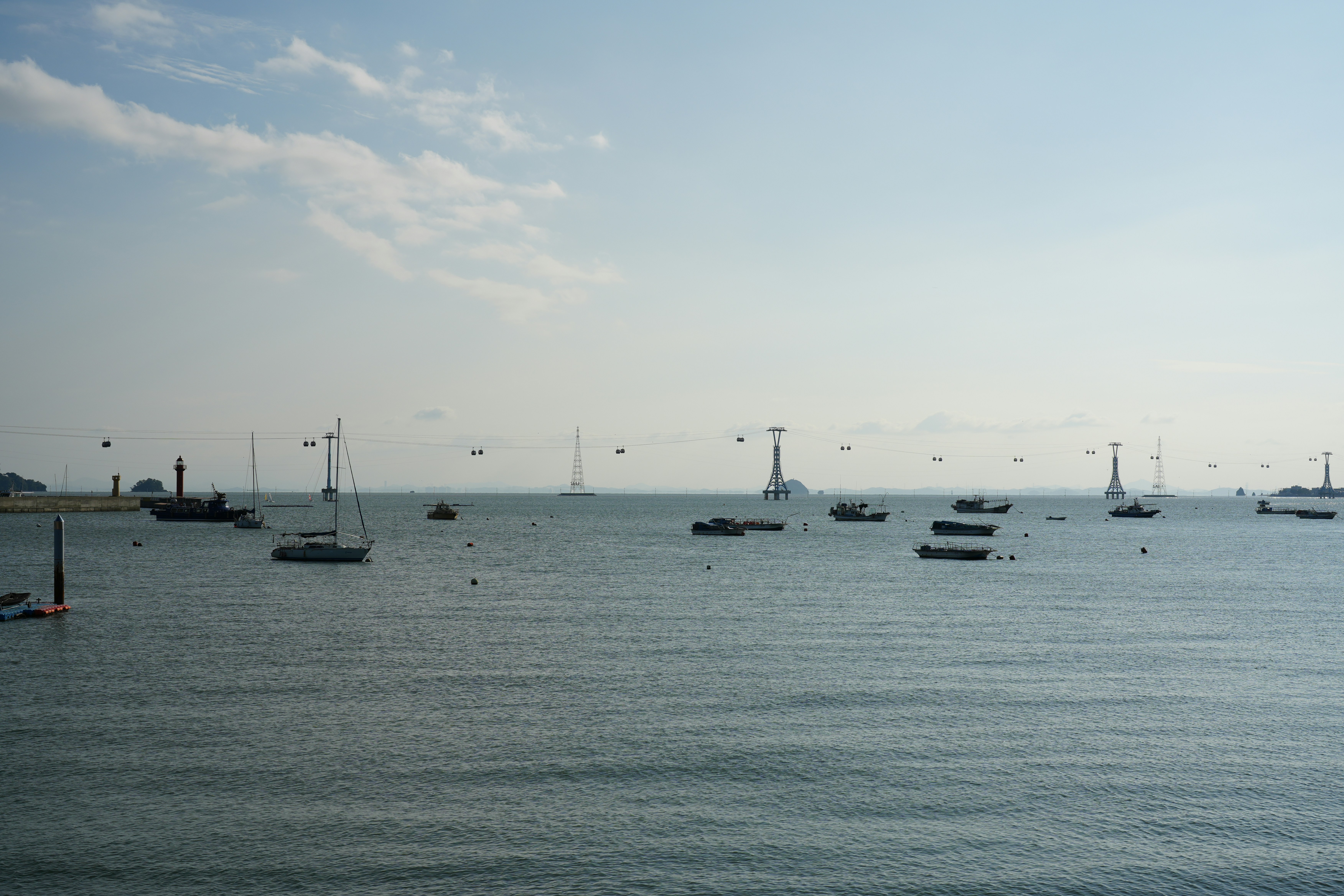 Calm Harbor: Boats Weaving Across a Quiet Sea at Midday