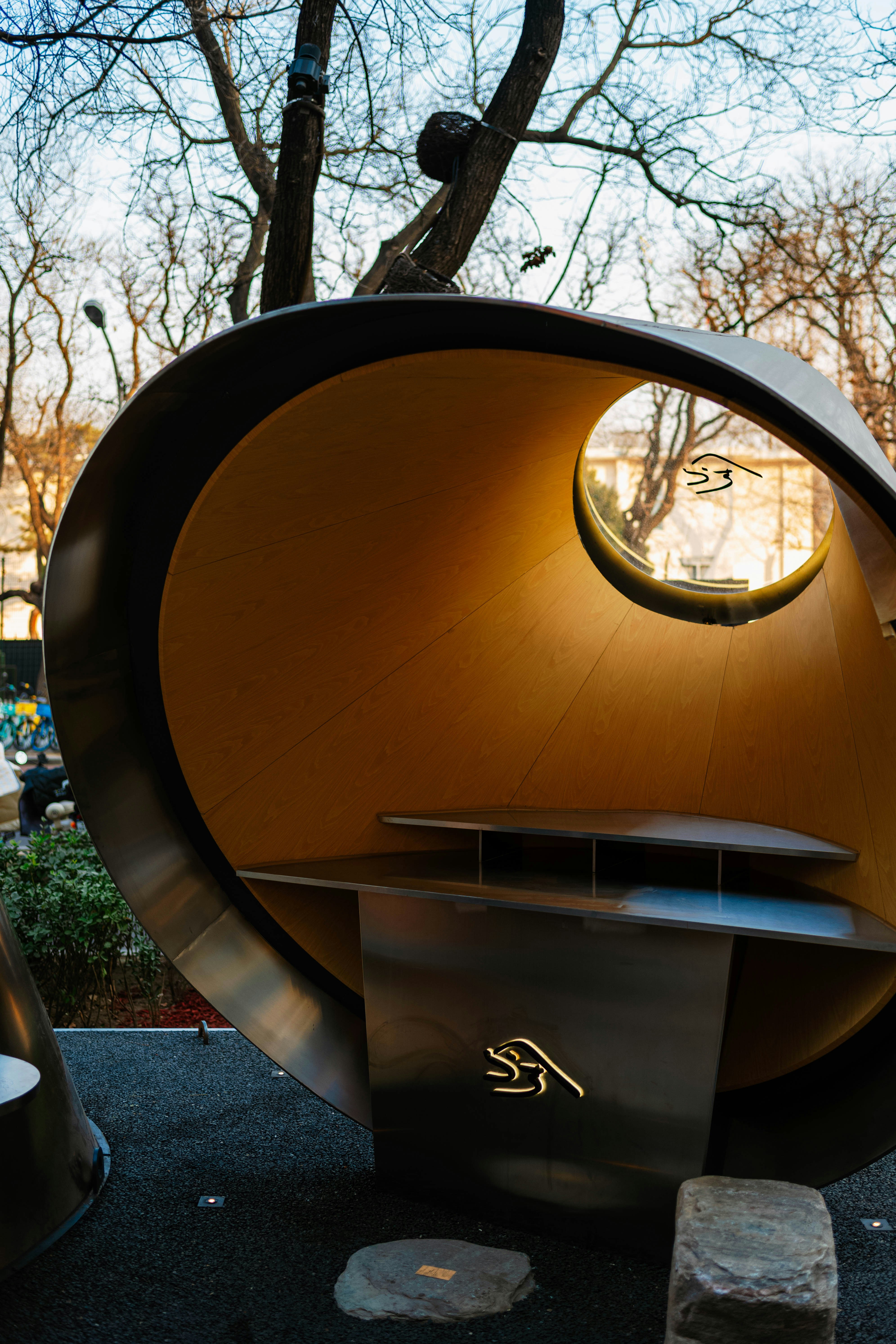 Circular Glow: A Shell of Modernity Framing a Park Scene