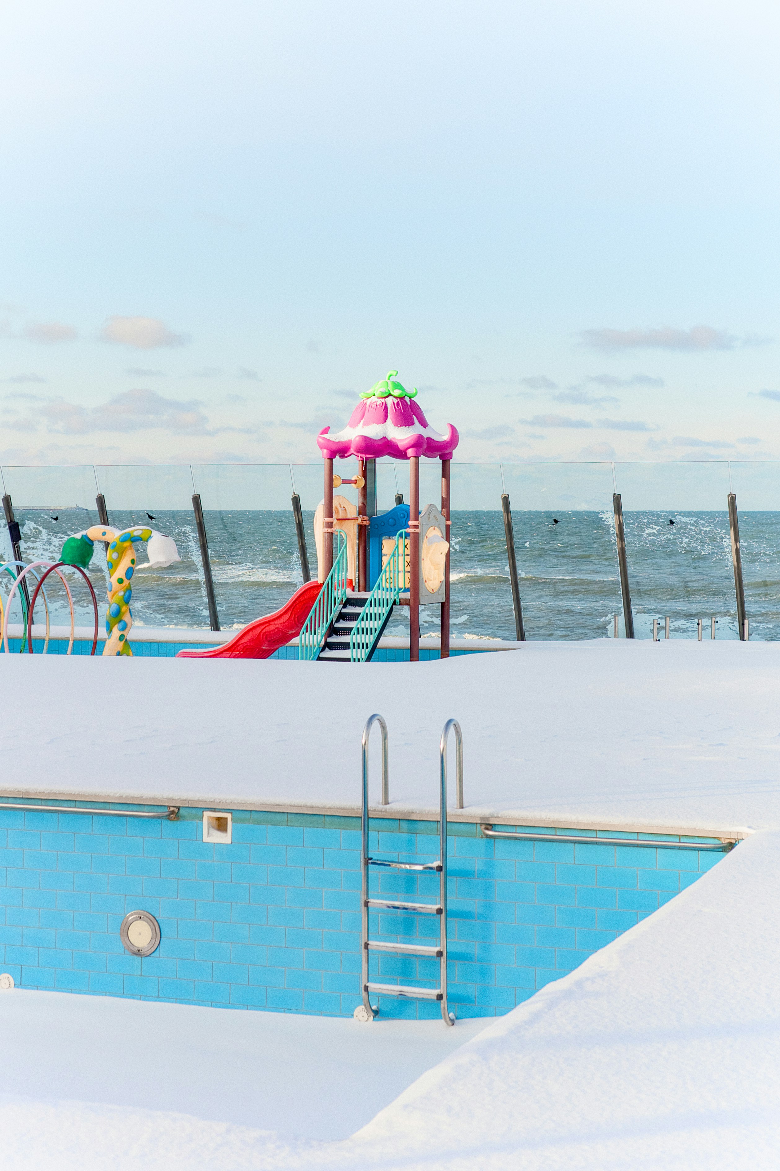 Snowy Pool Parade: A Colorful Playground by the Seashore