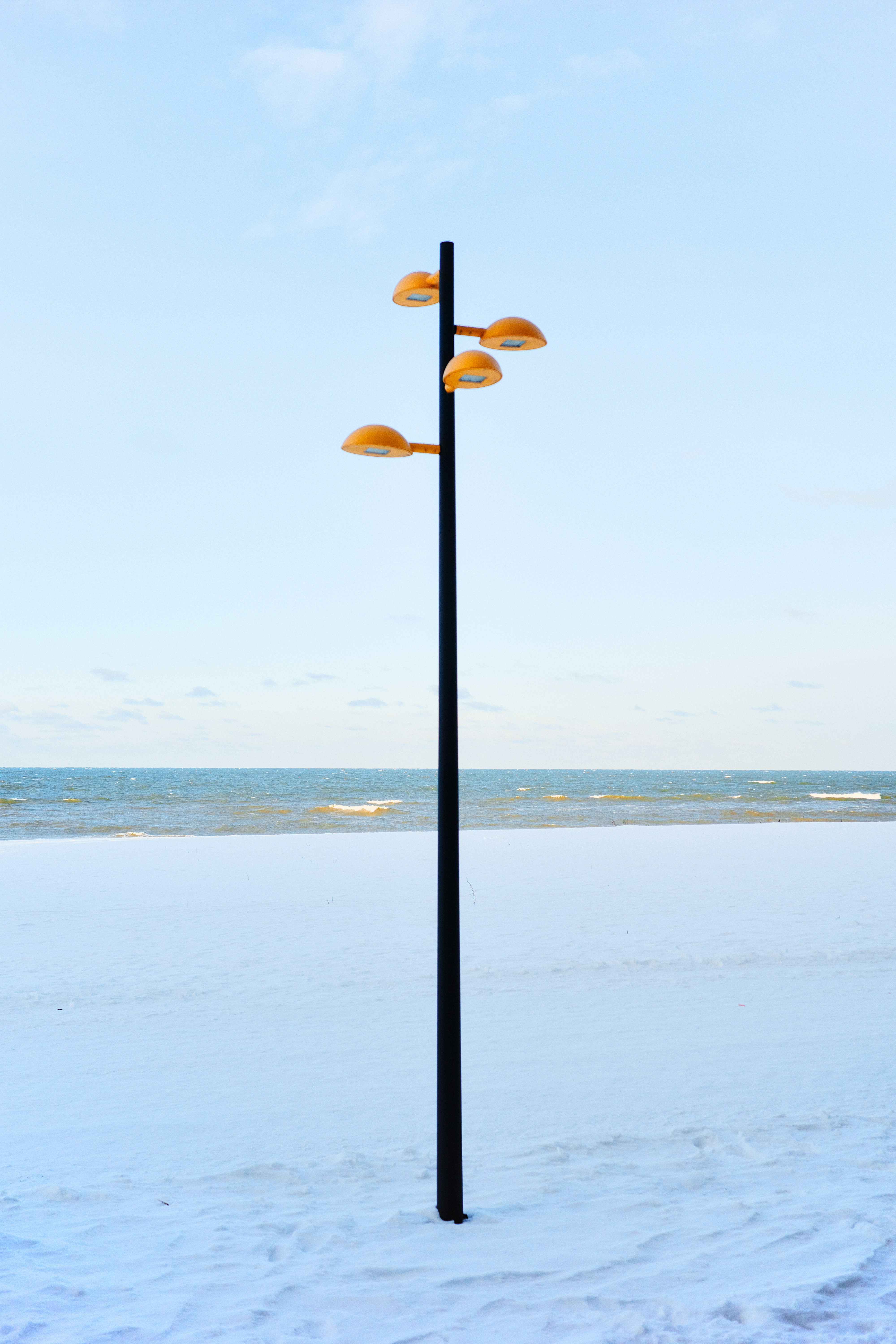 Lone Streetlamp Reaches Into a Snowy Seascape