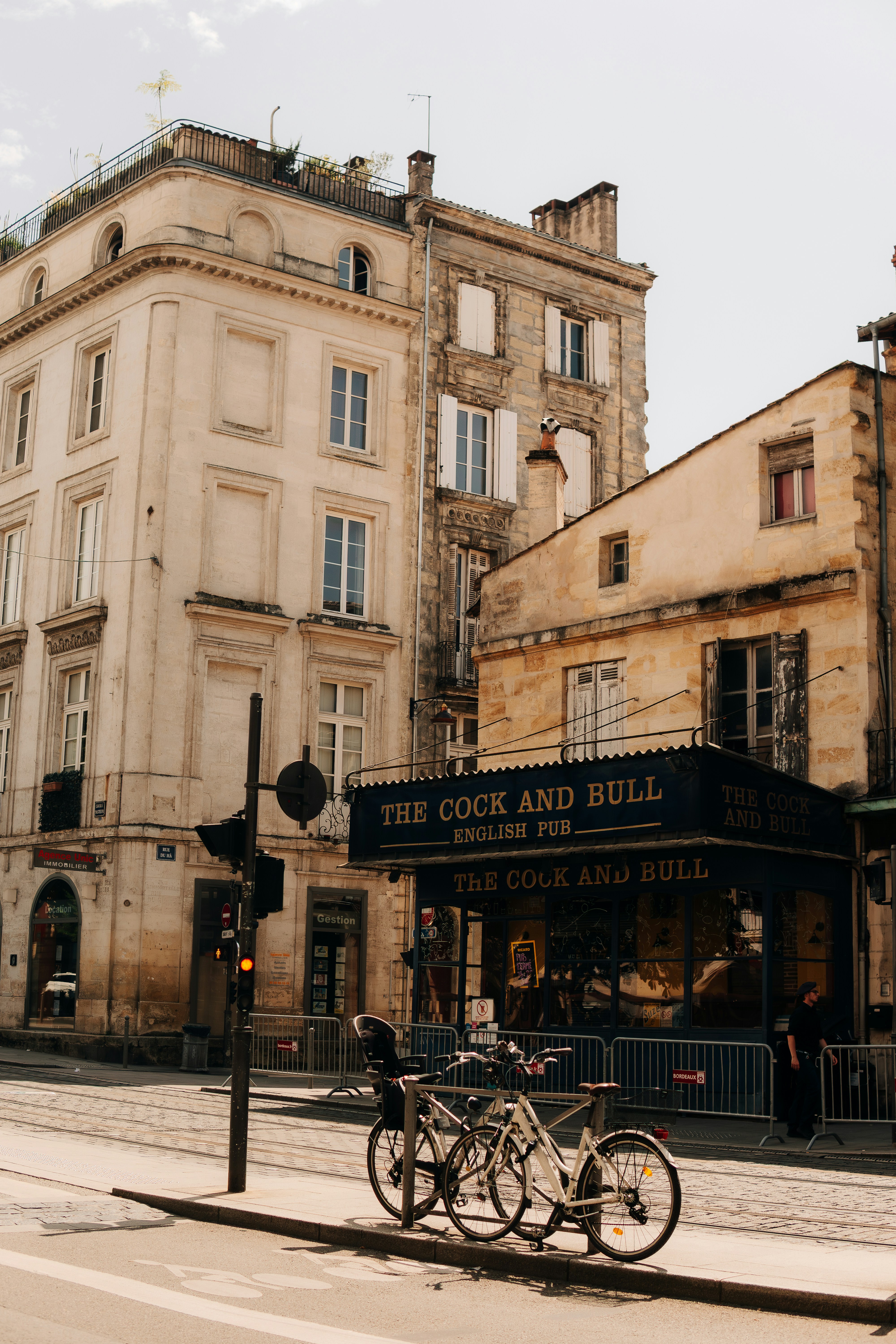 Sunlit Facade and Corner Pub: A Quiet Street in Warm Tone