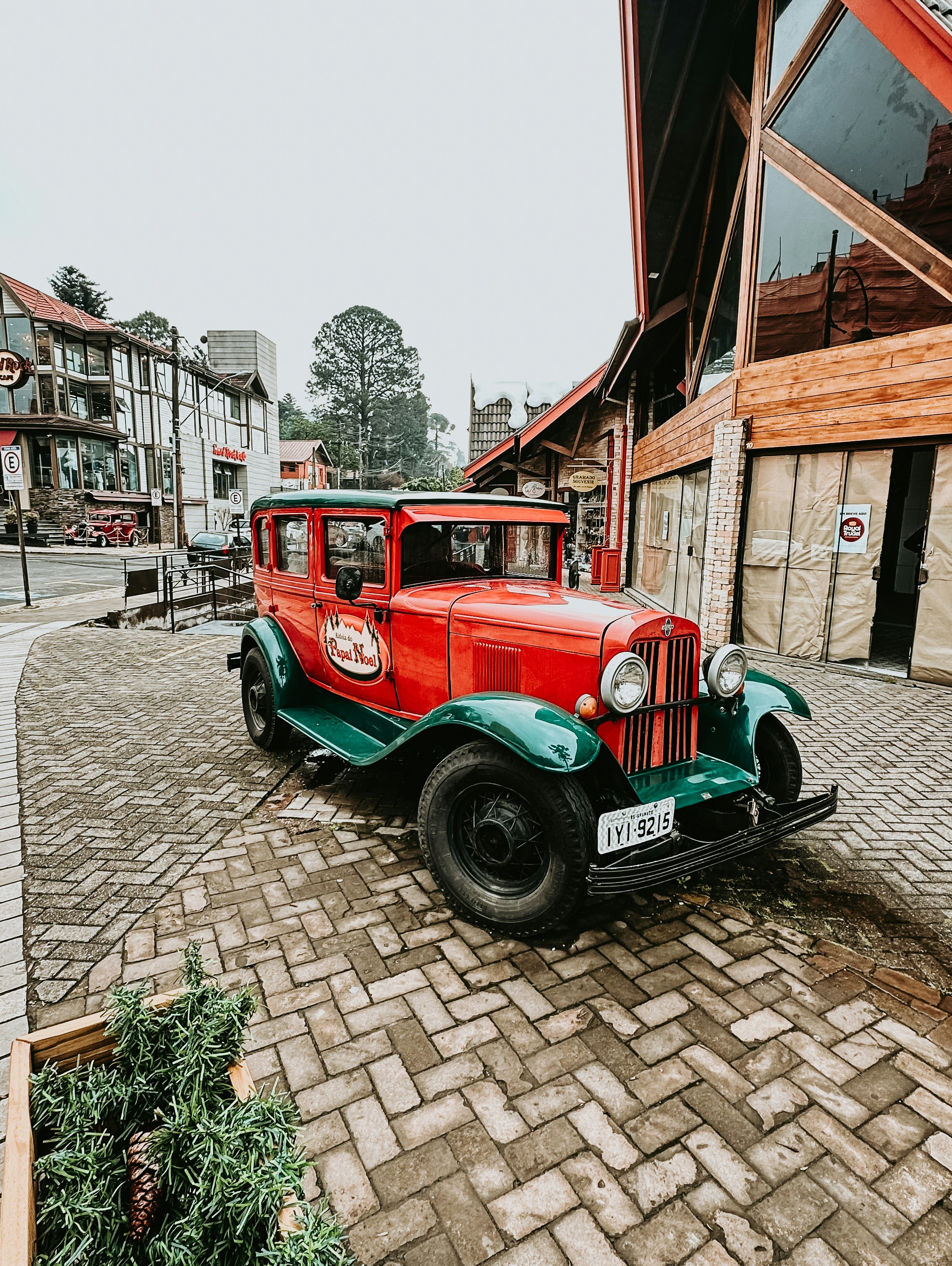 Red Vintage Sedan Anchors a Charming Cobblestone Street