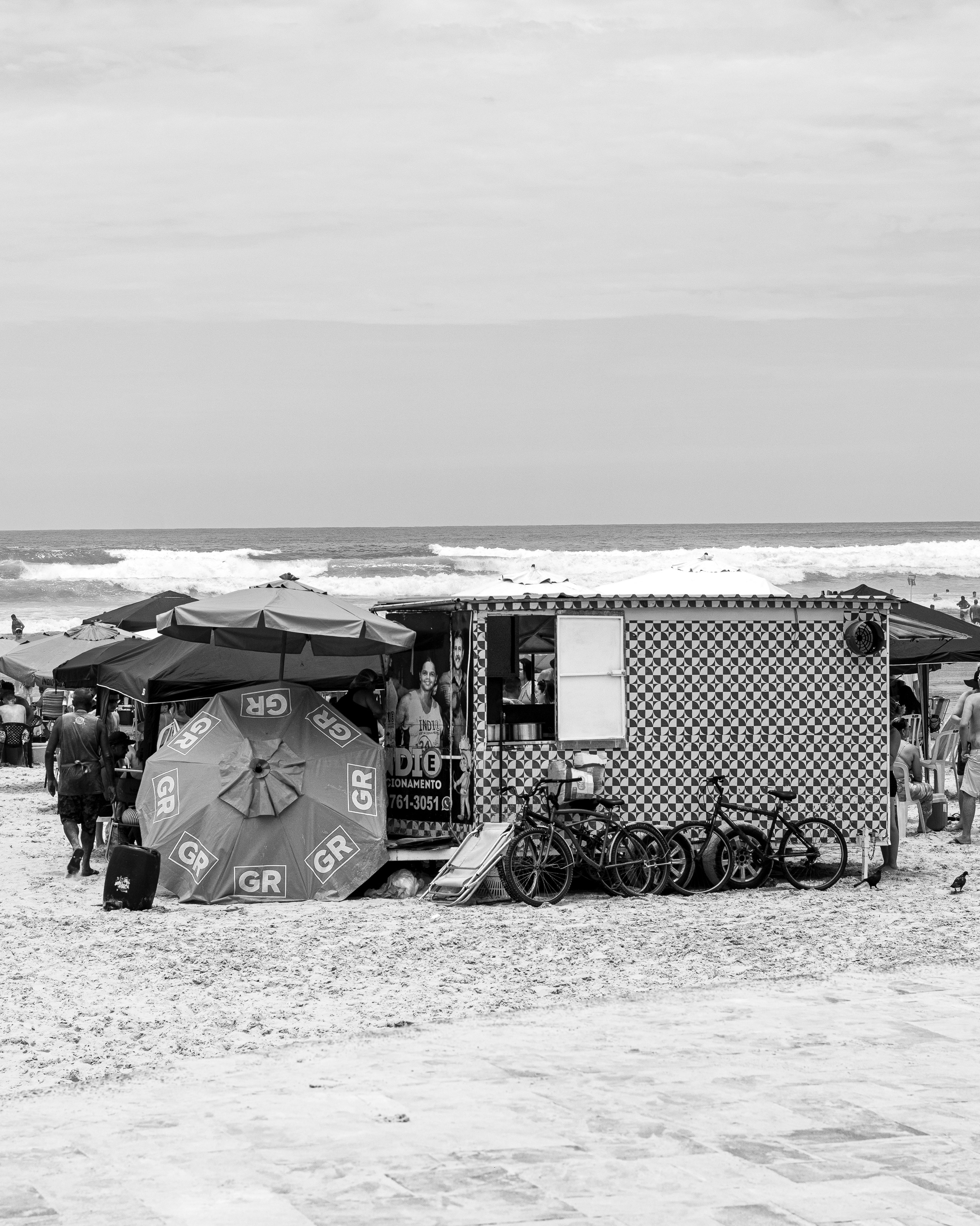 Beachside Vendor Row: Tents, Bikes, and Waves