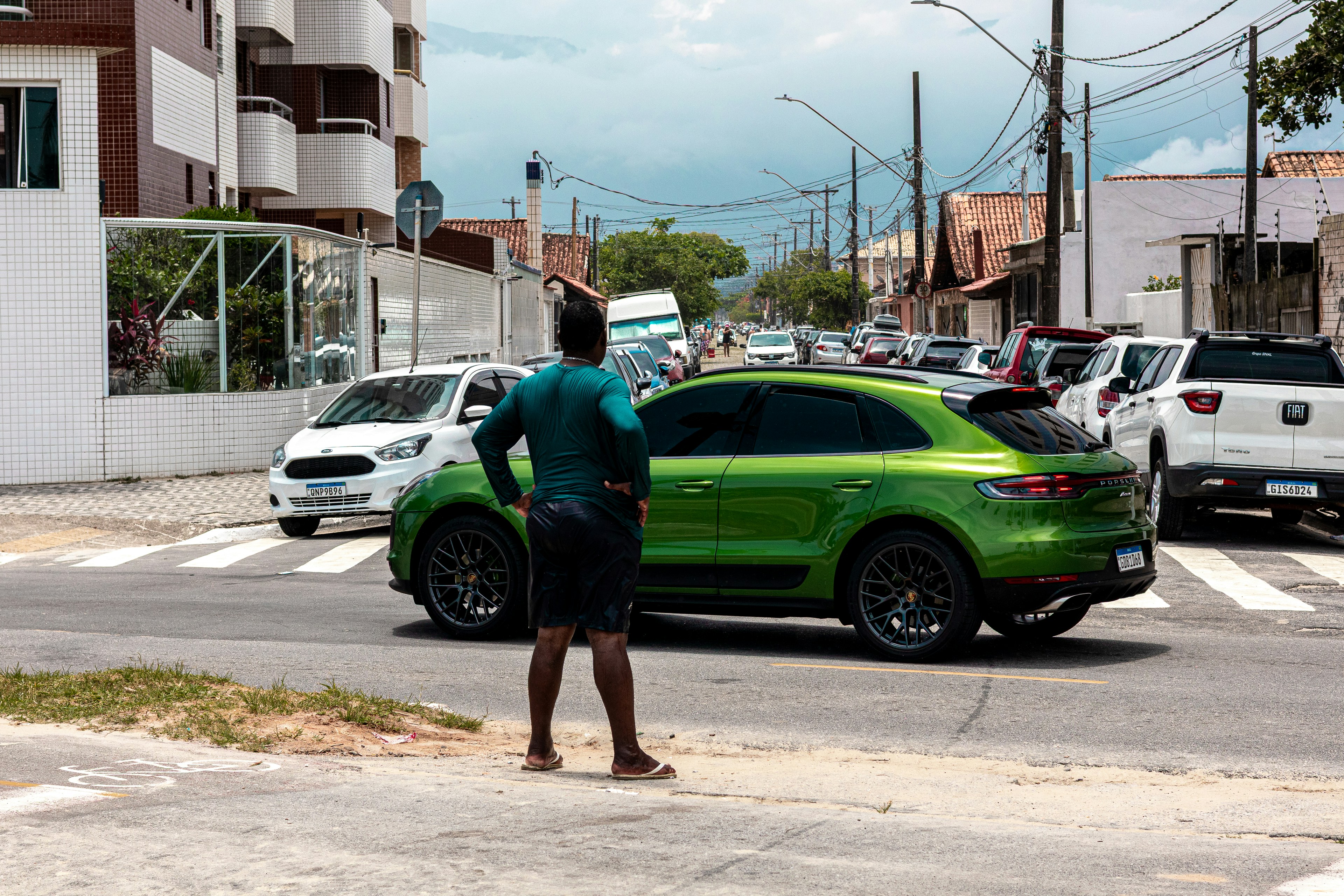 Green SUV Standoff at a Quiet Street Crossroad