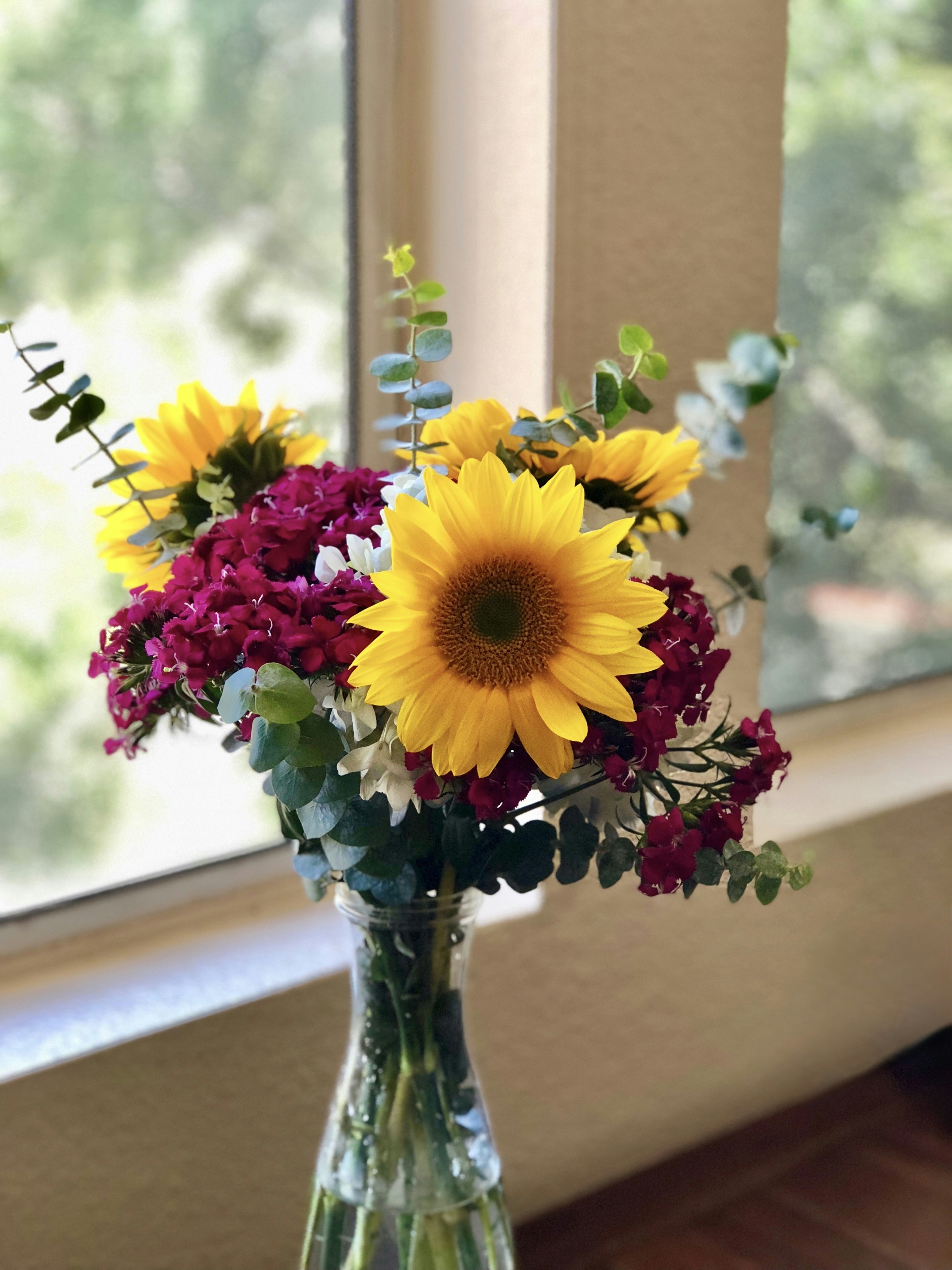 Sunlit Bouquet with Center Sunflower on a Window sill