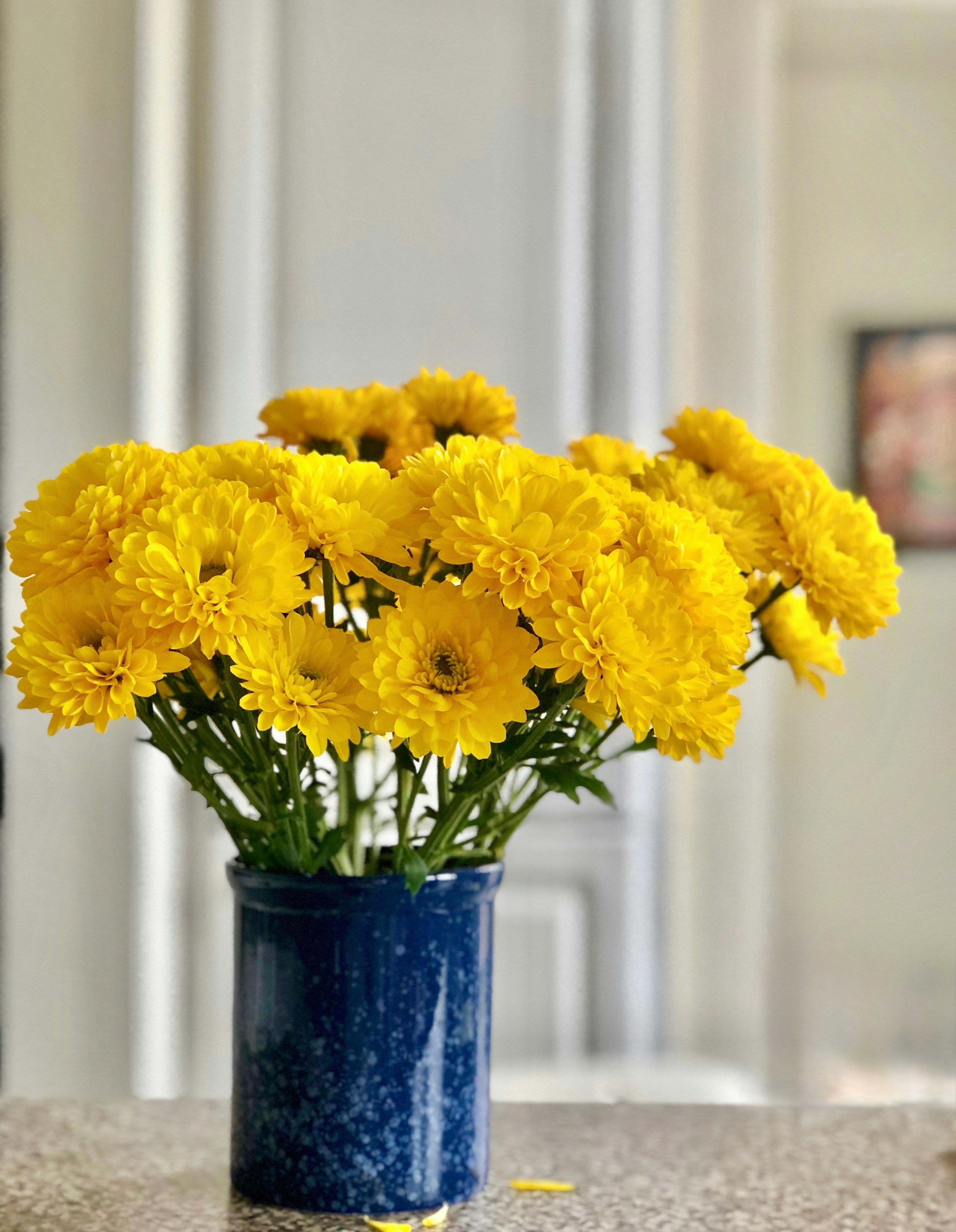 Golden Bloomed Centerpiece in a Blue Vase