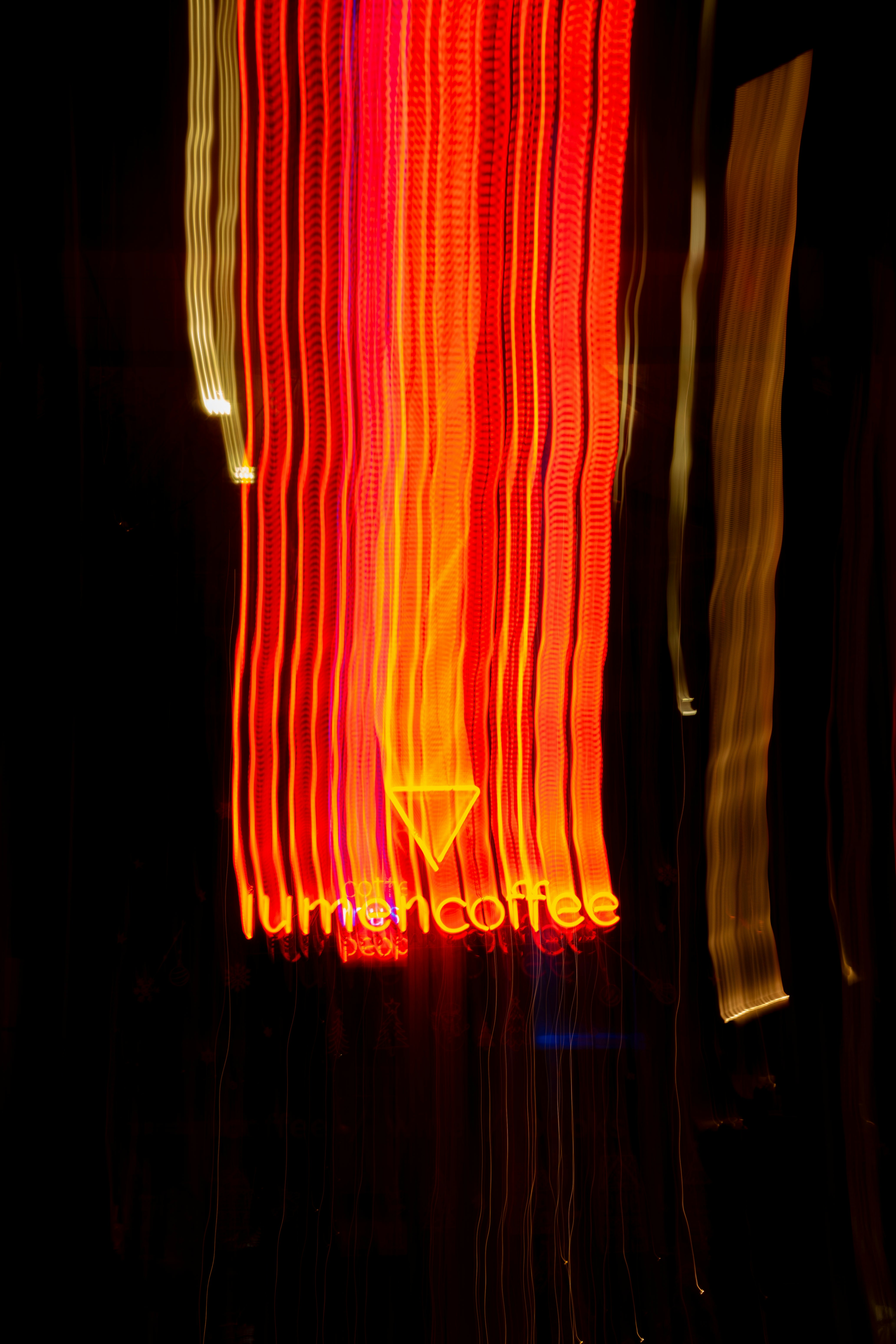 Neon Ribbon Cascade at a Blurred Night Signing