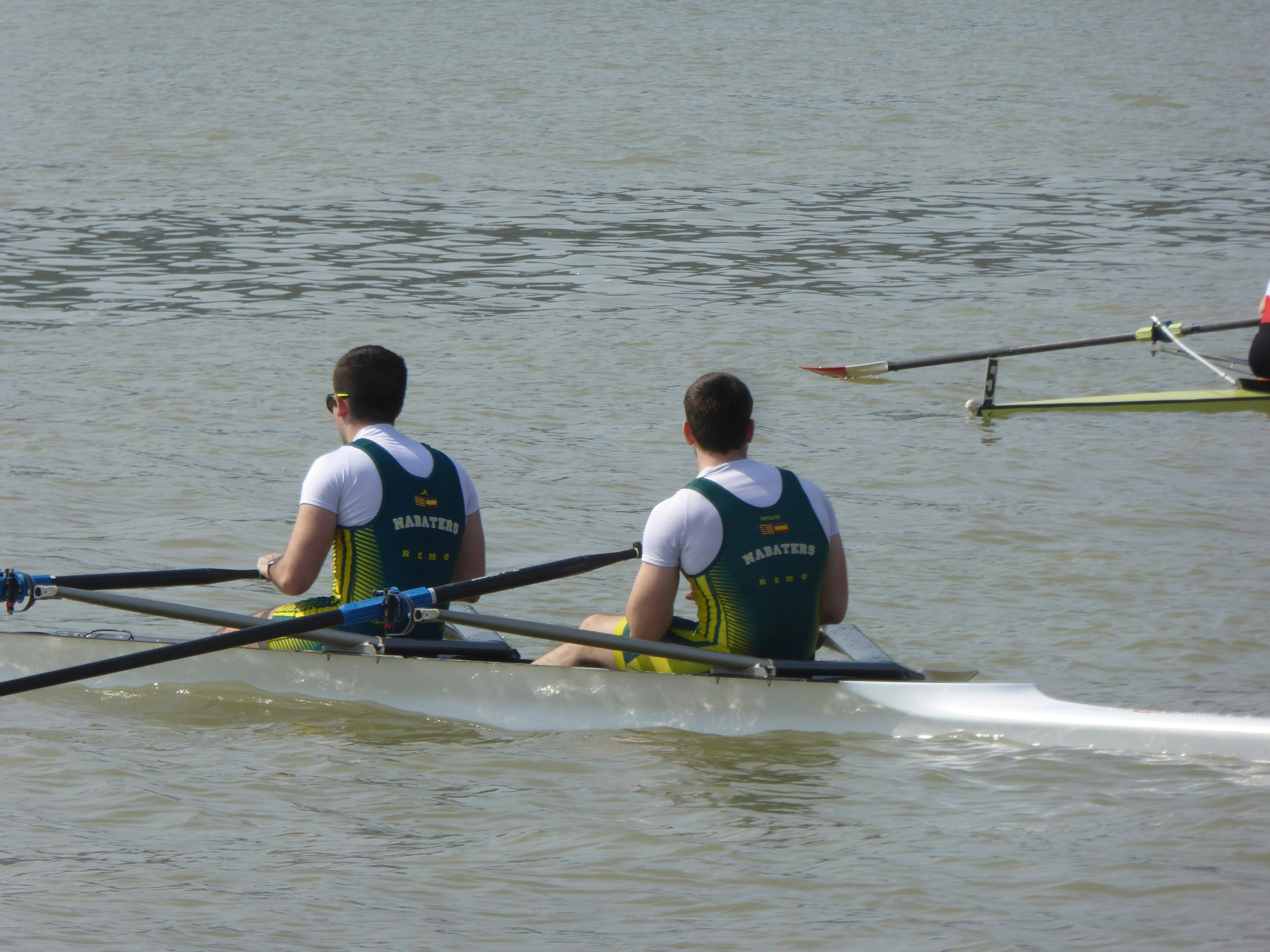 Two rowers in a boat on the water
