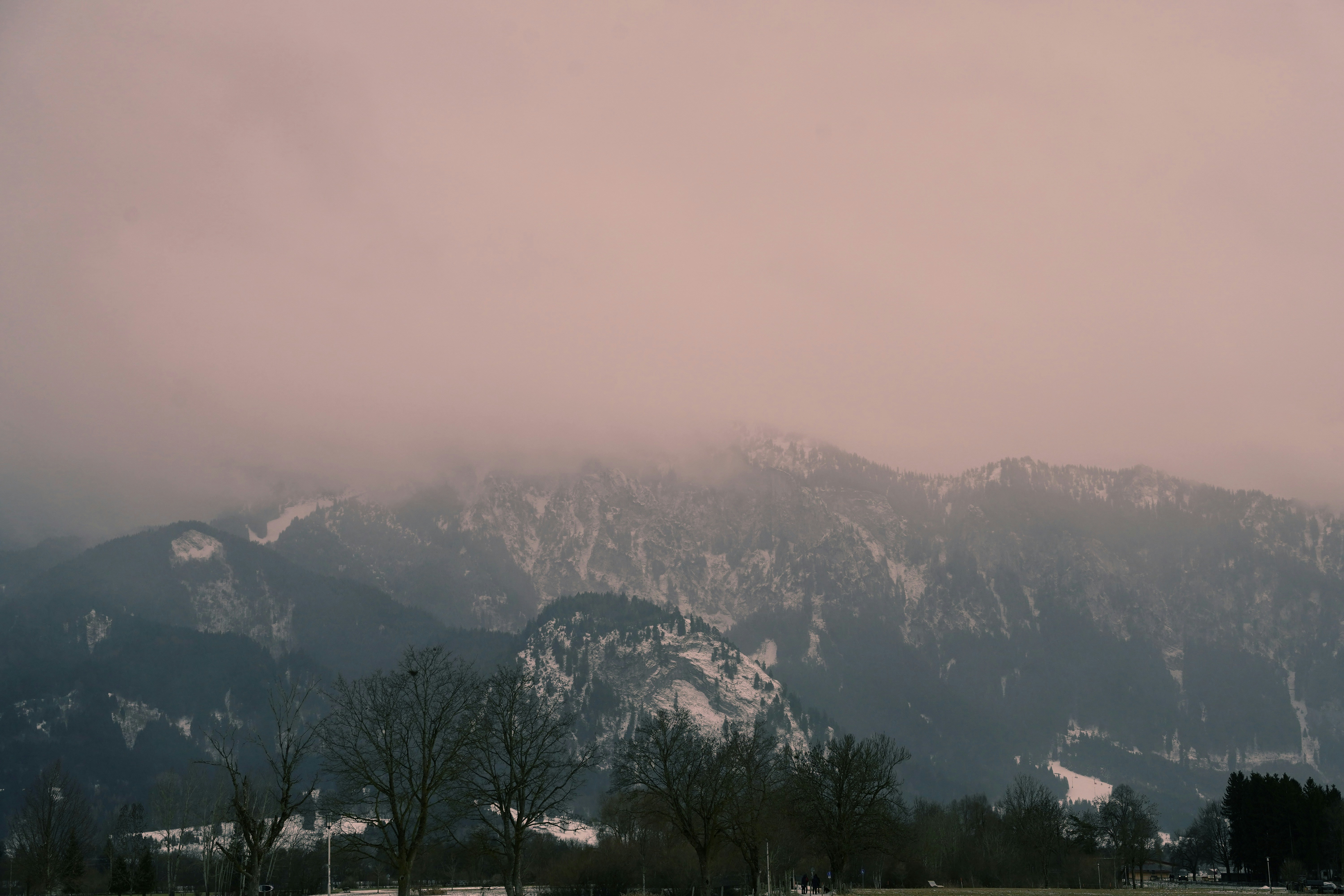 Mist over the rolling alpine ridges at dusk