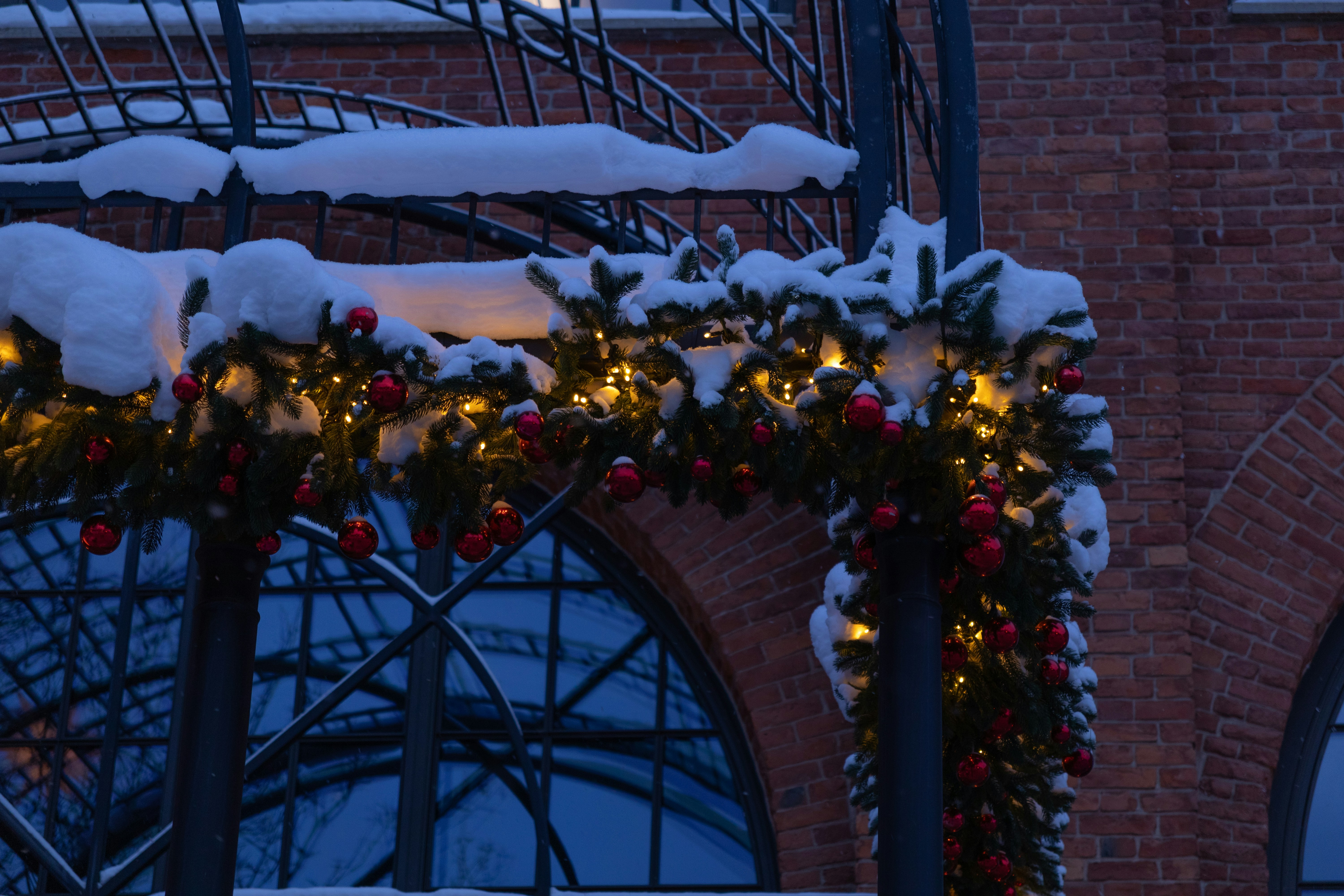 Snow-laden holiday archway with glowing garlands