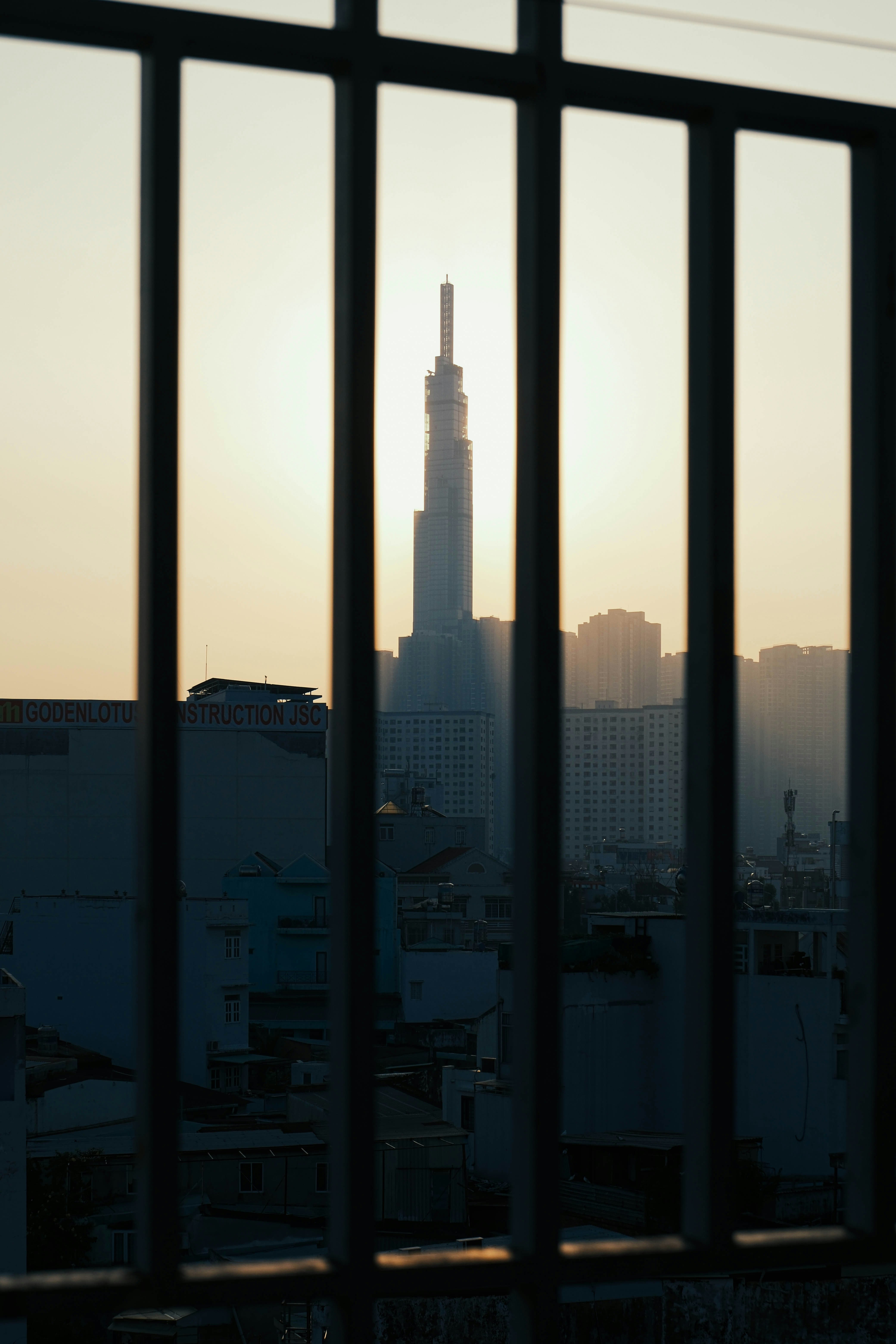 Bars of the City: A Sunset Silhouette Through Window Grilles
