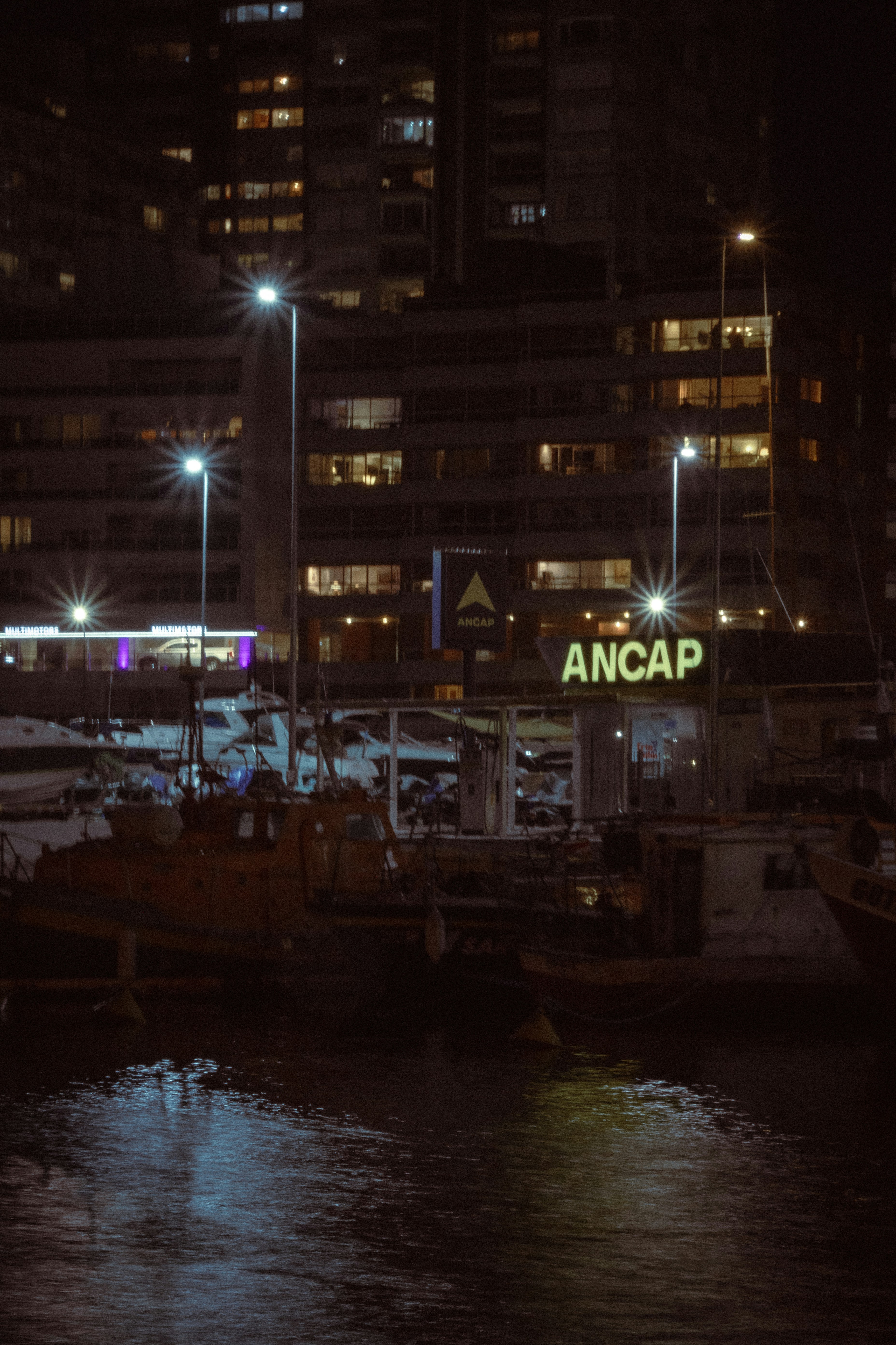 Night Marina Sign: Light Reflections and Docks in an Urban Harbor