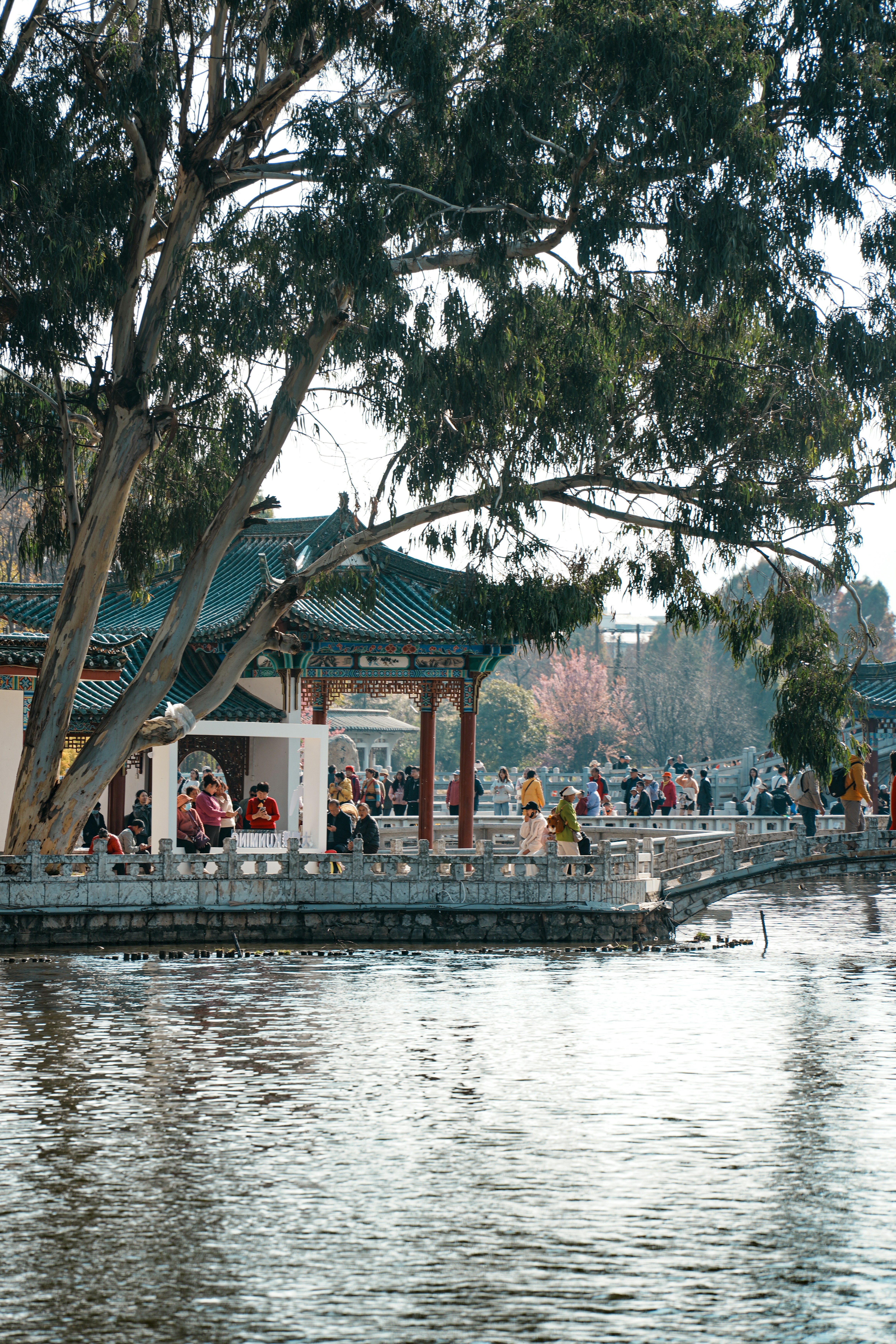 Quiet Pedestrian Bridge by a Traditional Pavilion Amid Lantern-Lit Courtyard